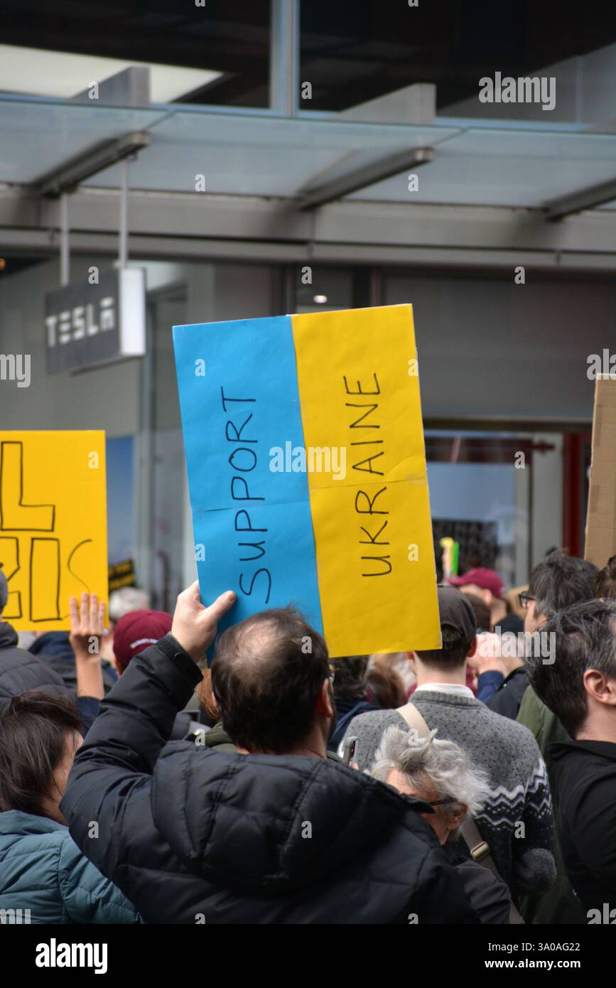 Signs of support for the Ukraine at a protest against Elon Musk and ...