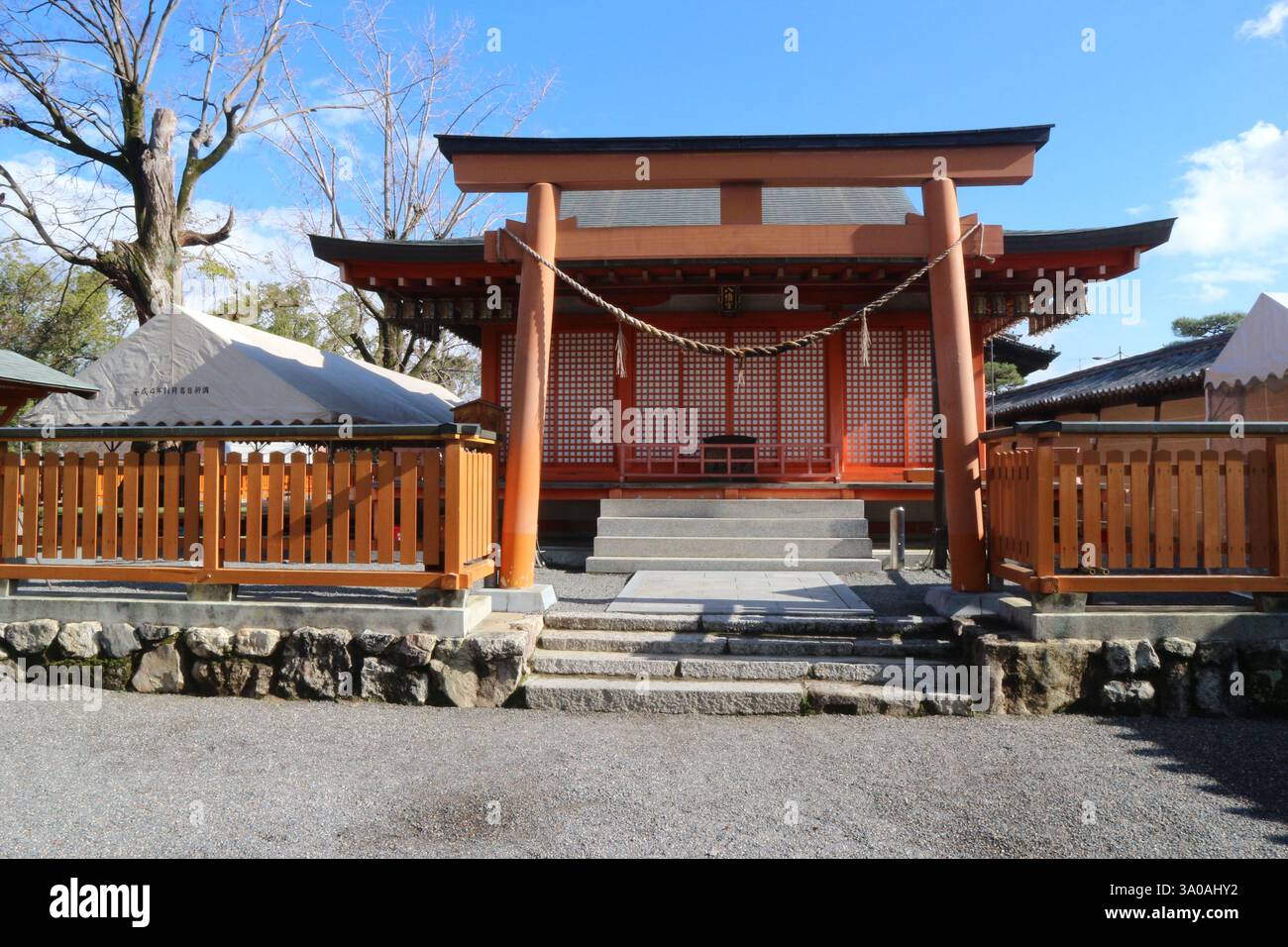 A beautiful preserved Shinto shrine with a bright wooden facade under a ...
