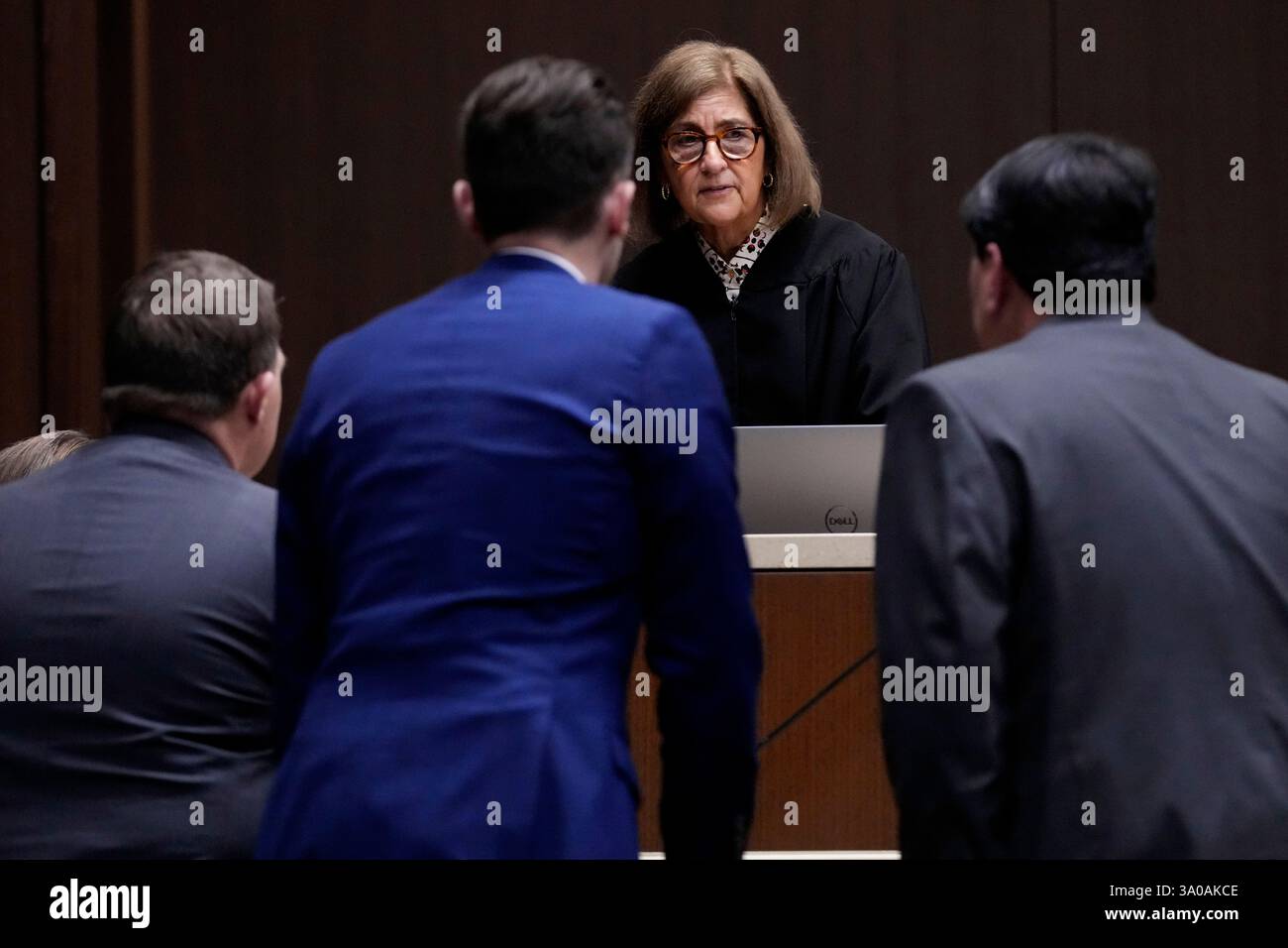 FILE - Judge Victoria A. Rossetti, second from right, talks to Robert E ...