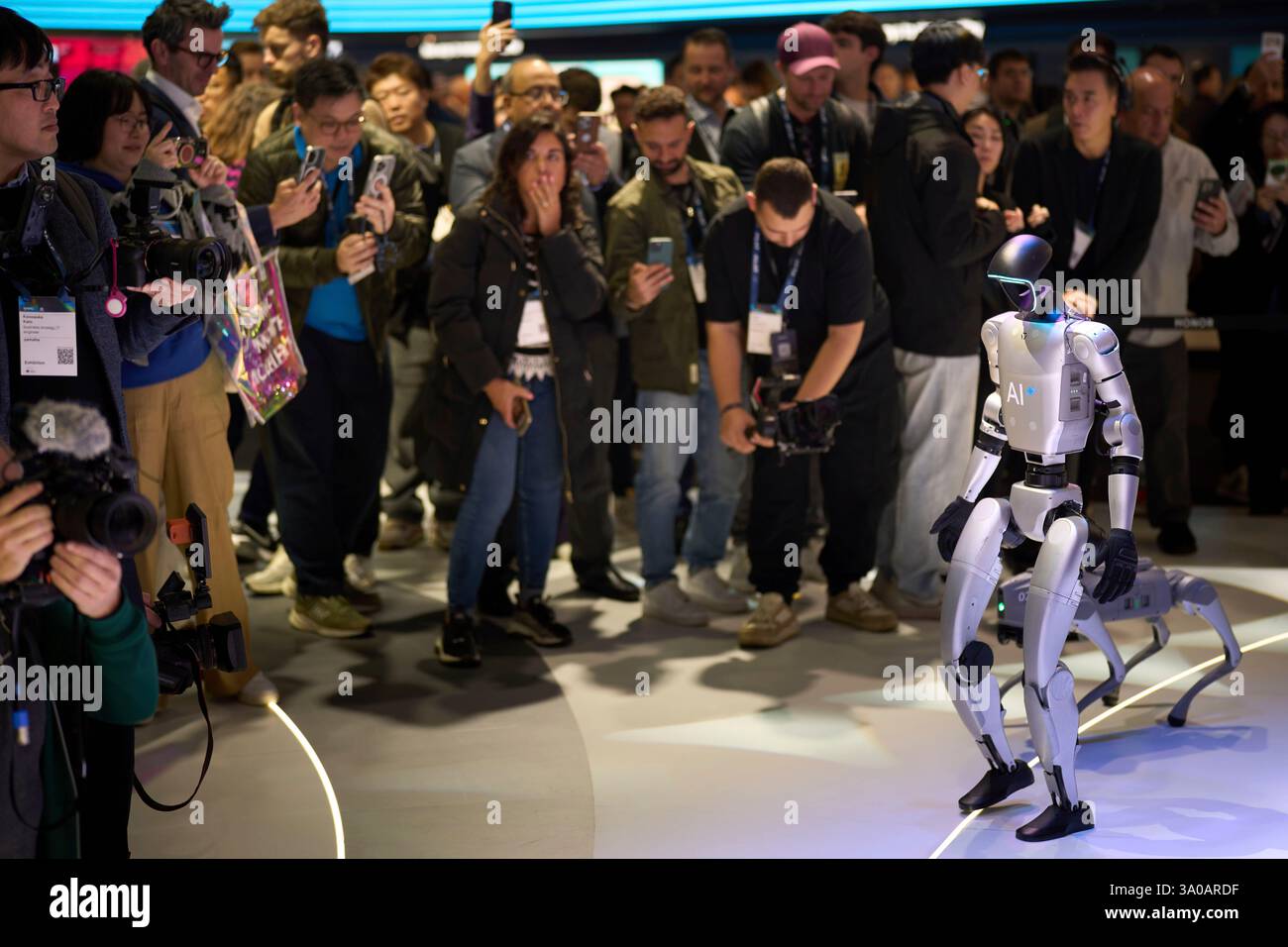 Visitors look at a robot manufactured by Honor AI, at the Mobile World ...