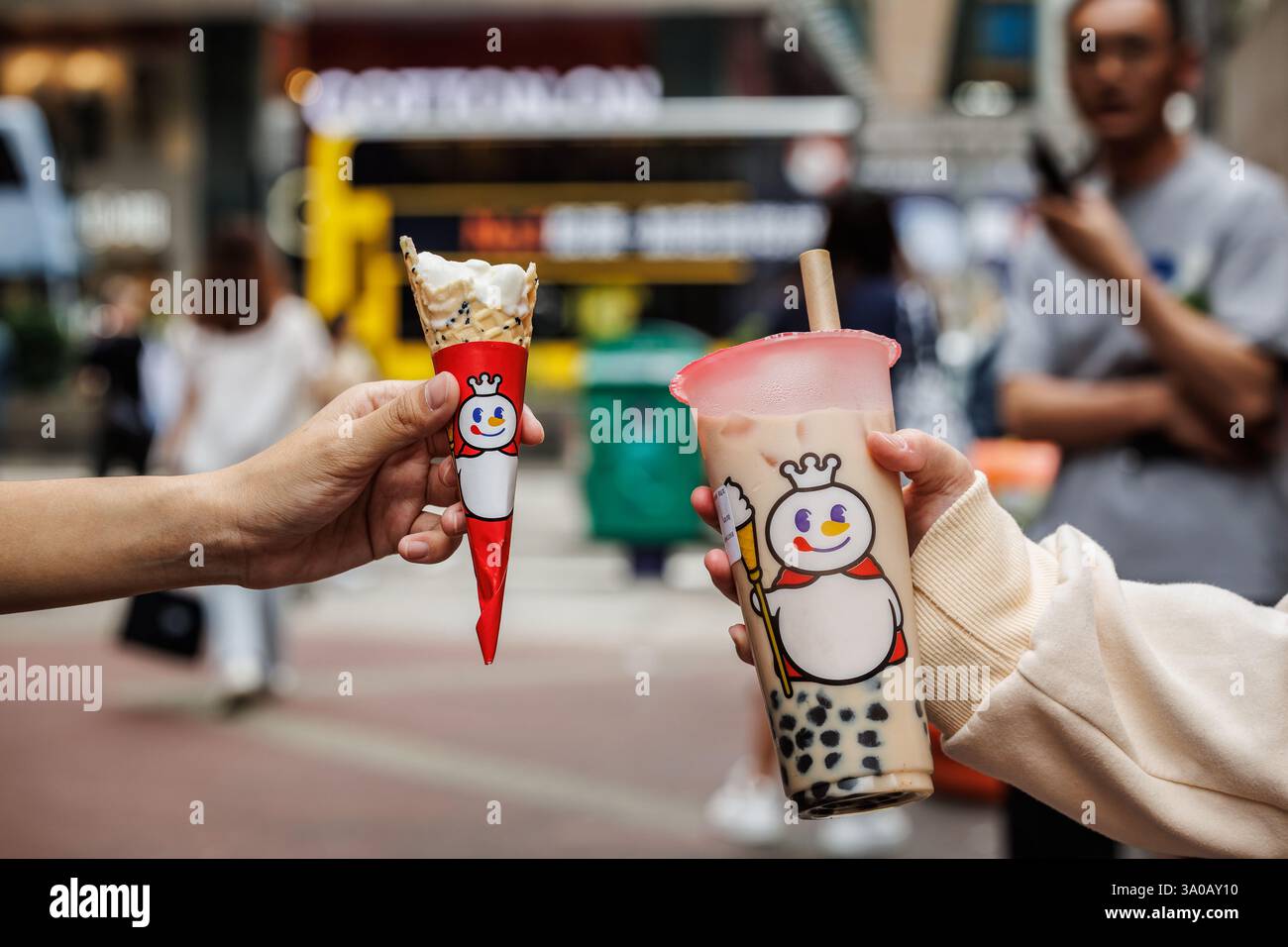 Hong Kong, China. 03rd Mar, 2025. Customers hold Mixue ice cream and bubble tea in Hong Kong ...