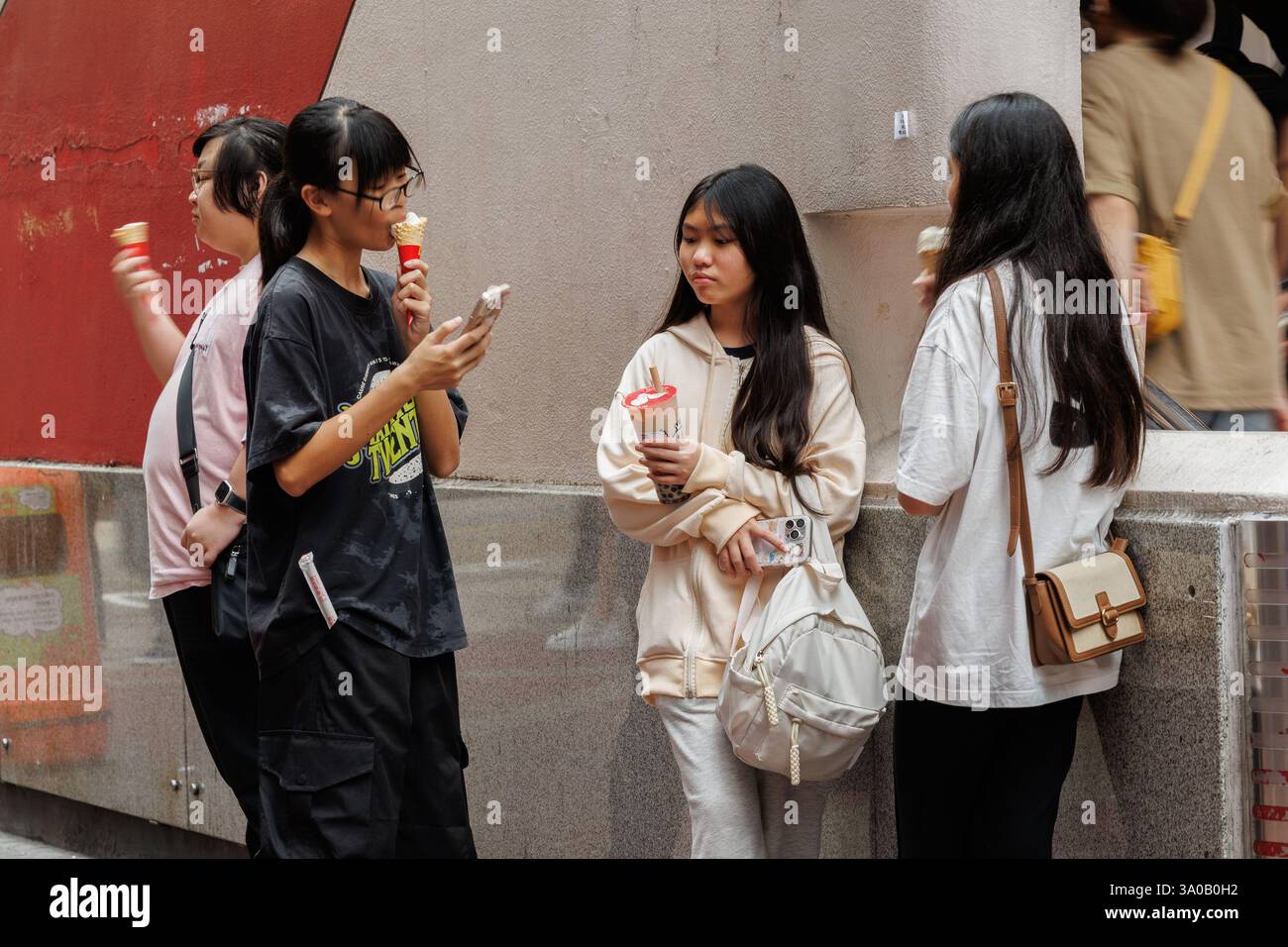 Customers seen eating Mixue's ice cream in Hong Kong. The Chinese brand- Mixue, is a global ice ...