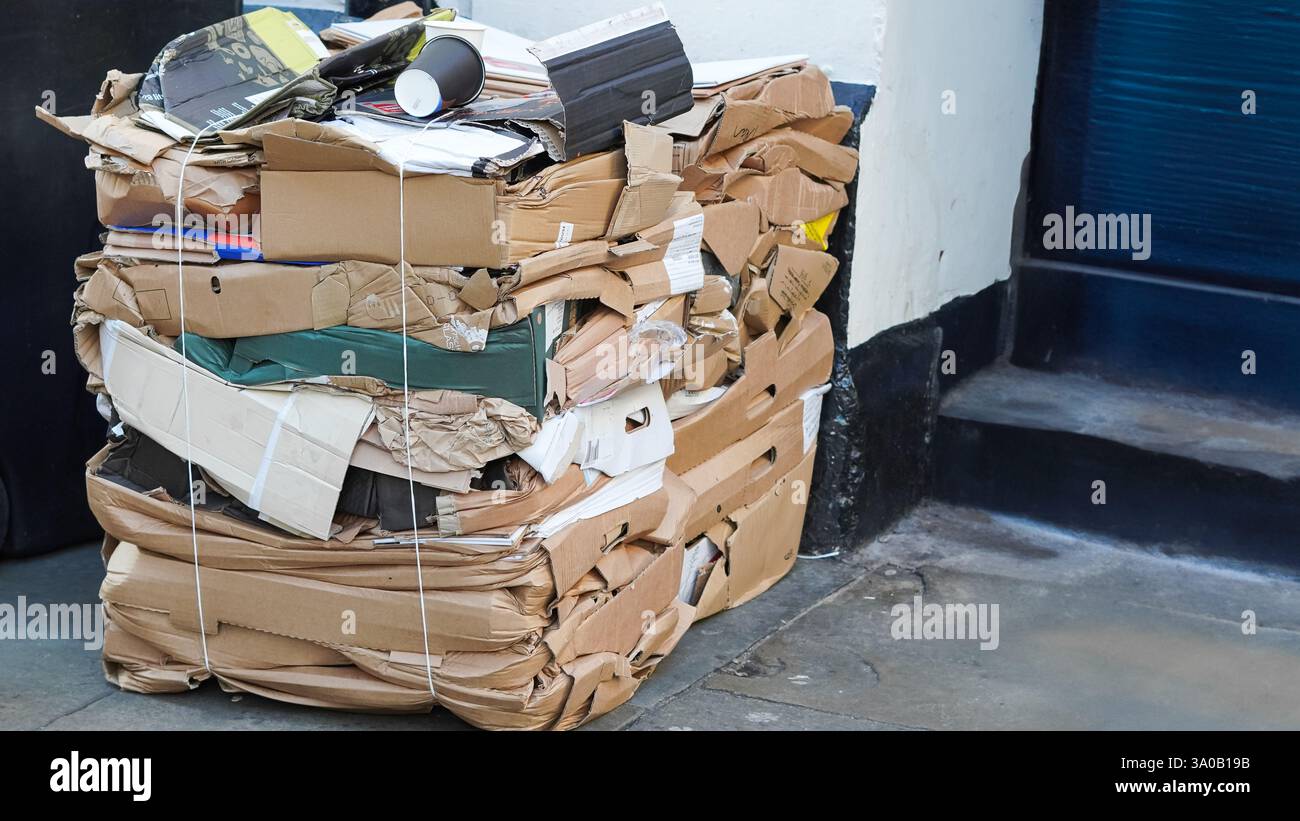 Stacked cardboard sorted outdoors for recycling, waste management ...
