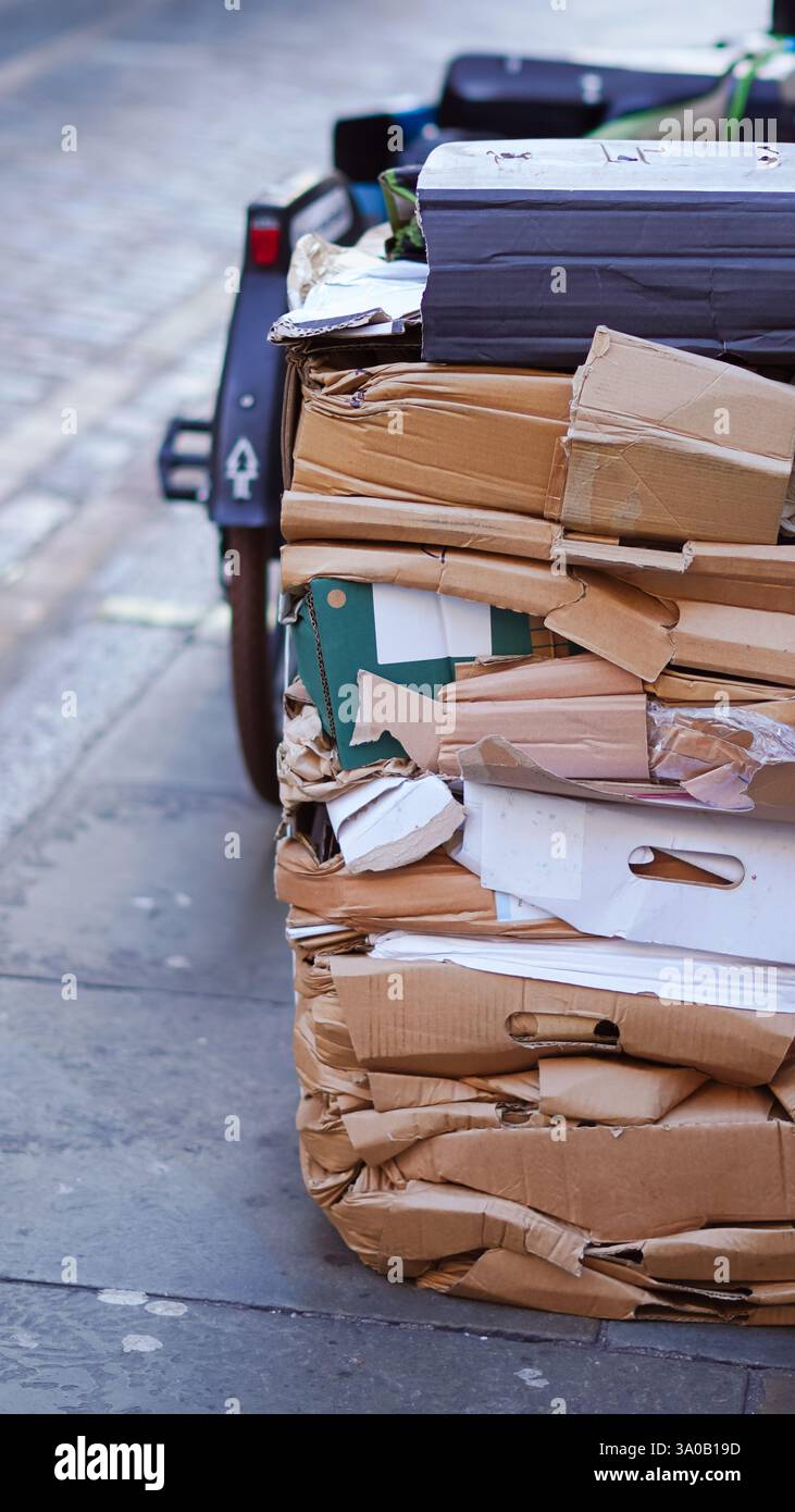 Large stacks of used cardboard outside, organized for waste recycling ...