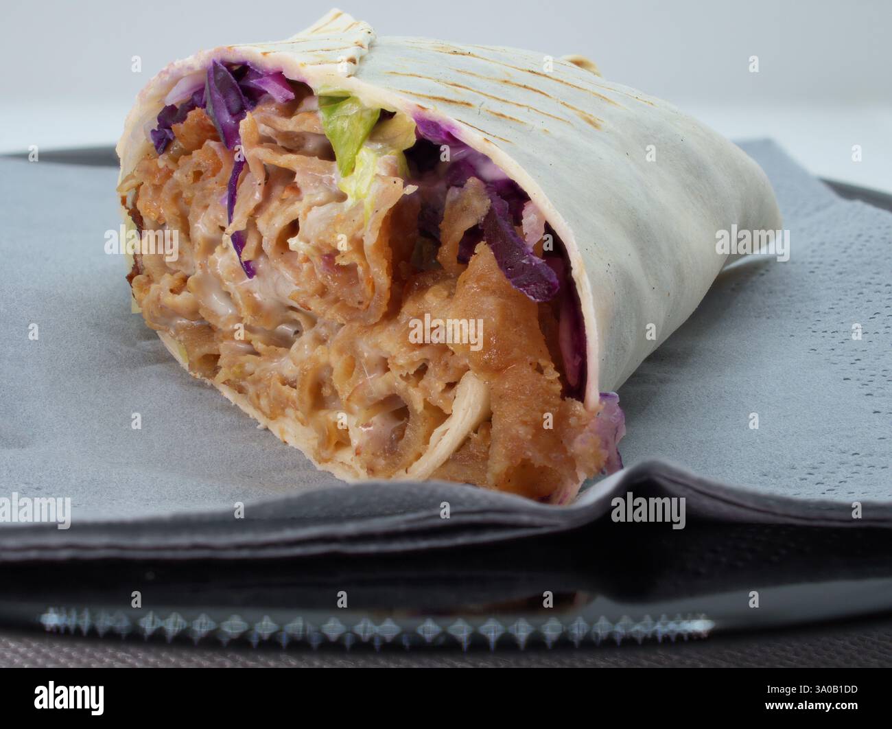 Turkish kebab wrapped in a tortilla with salad, red cabbage and ...