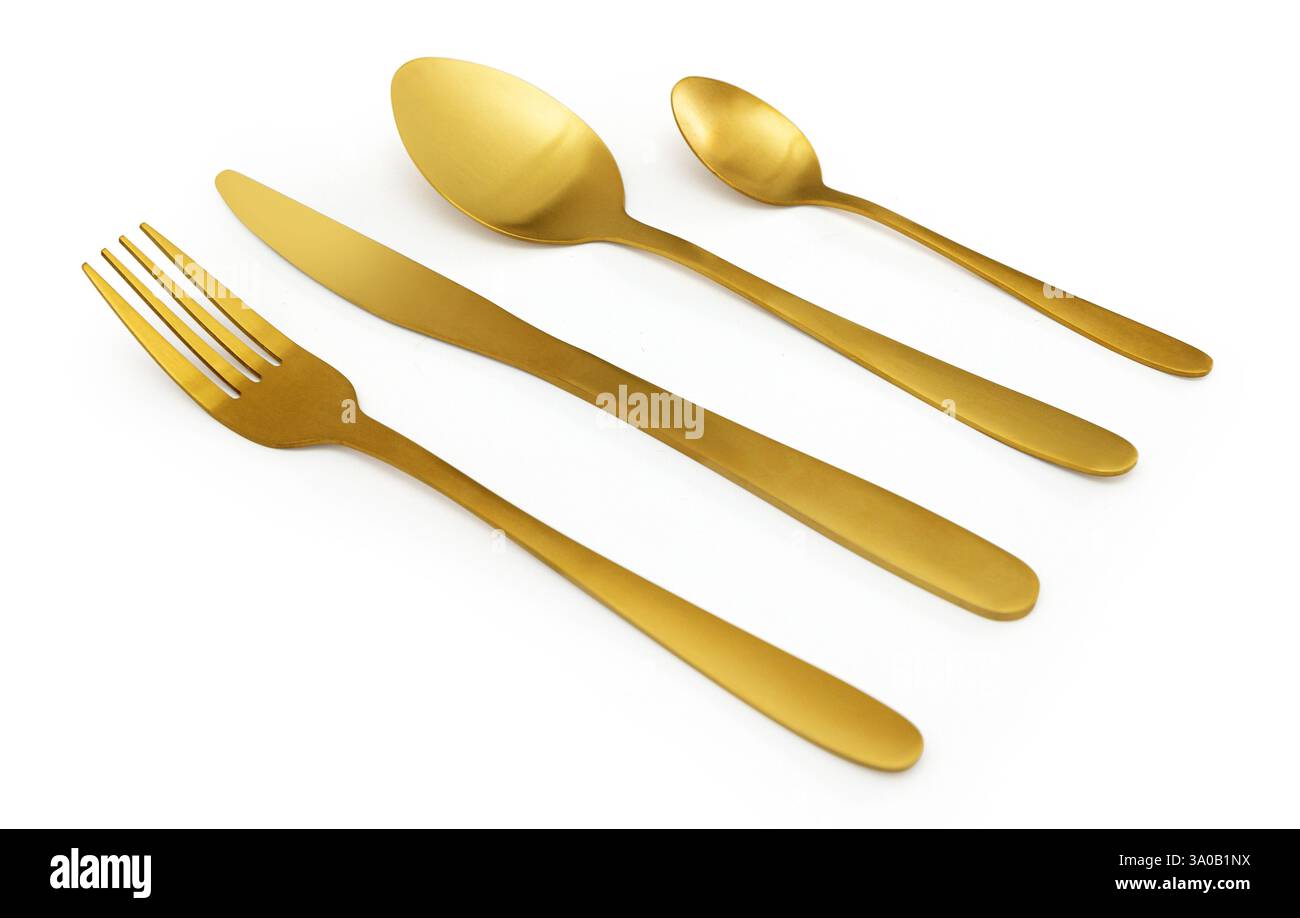 Golden fork, knife, and spoons lying on a white background, creating a ...