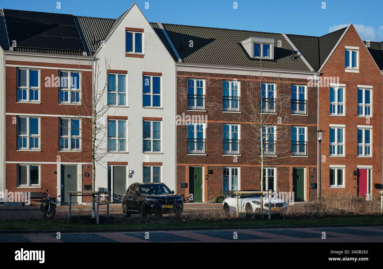 A row of modern townhouses in Assen, Netherlands, featuring red and ...