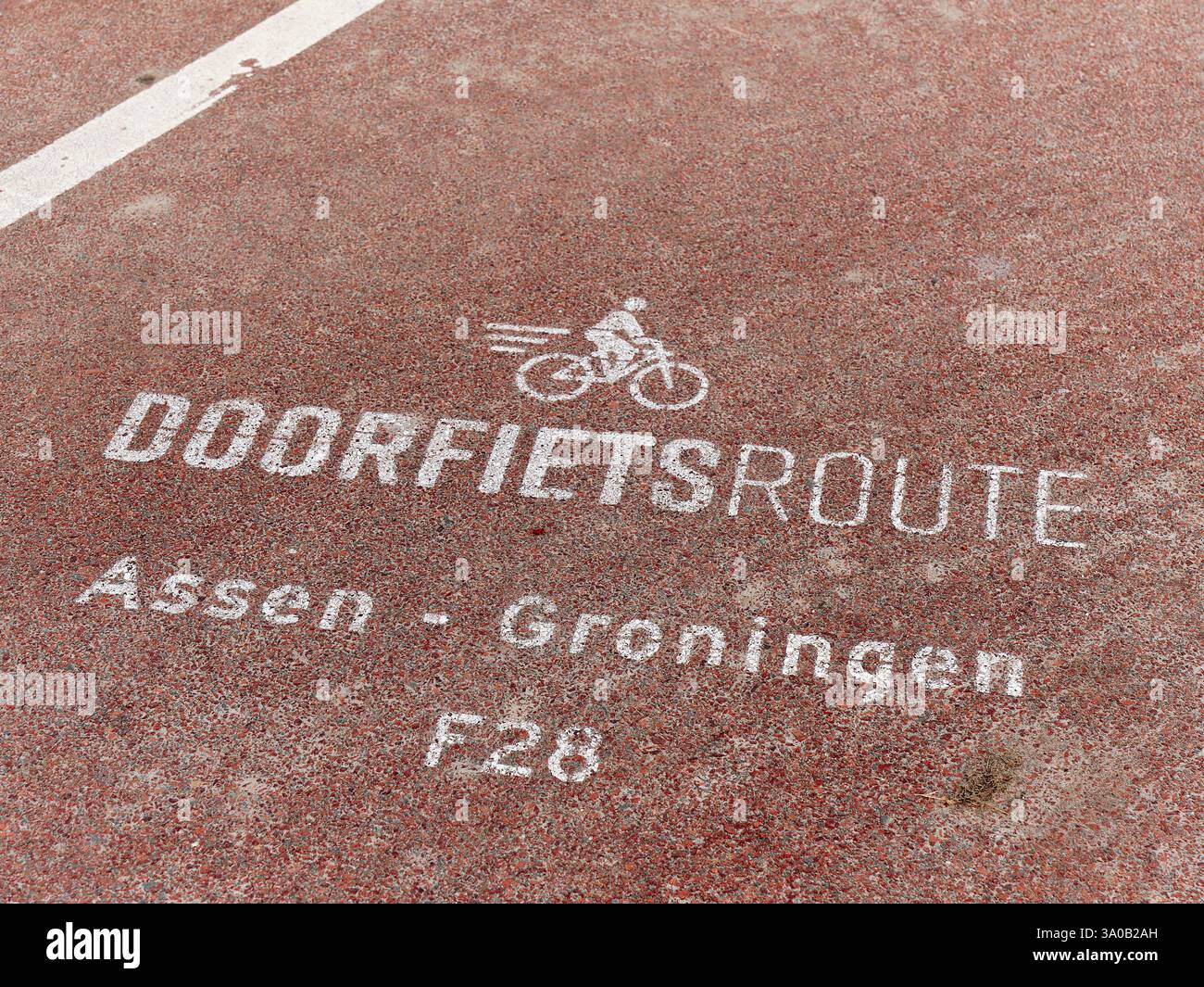 March 1, 2025 - Assen-Netherlands: White road marking on a red bike ...