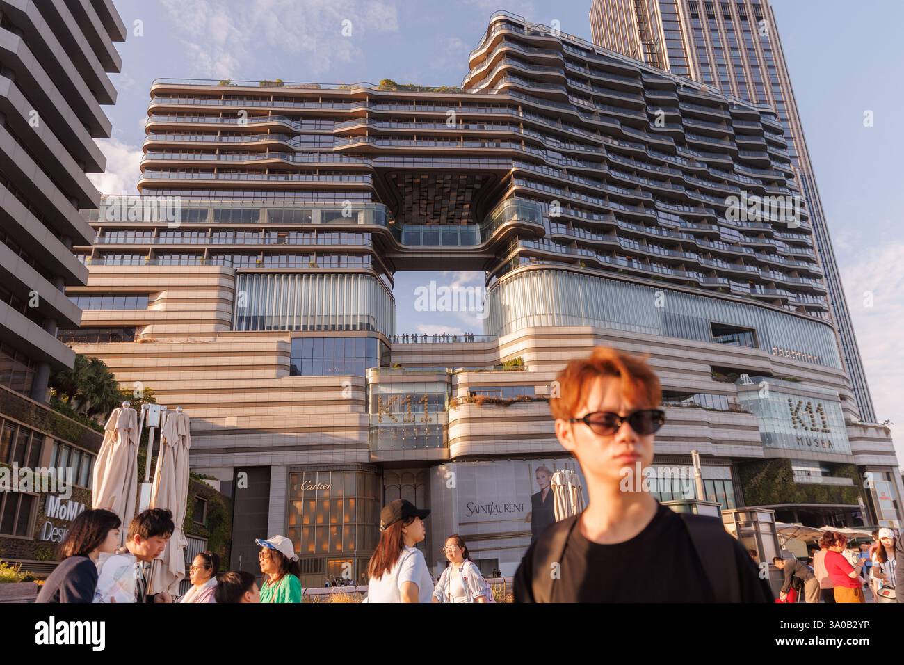 People walk past K11 Musea, a shopping mall combine with retail, art, culture and entertainment ...