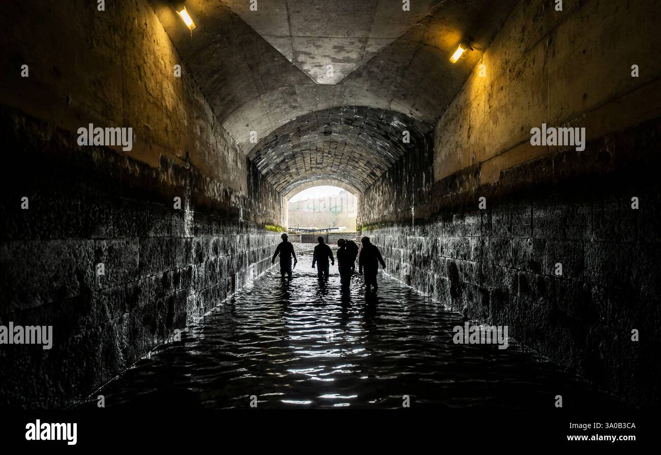 Canal & River Trust volunteers in a canal tunnel, after helping to give ...
