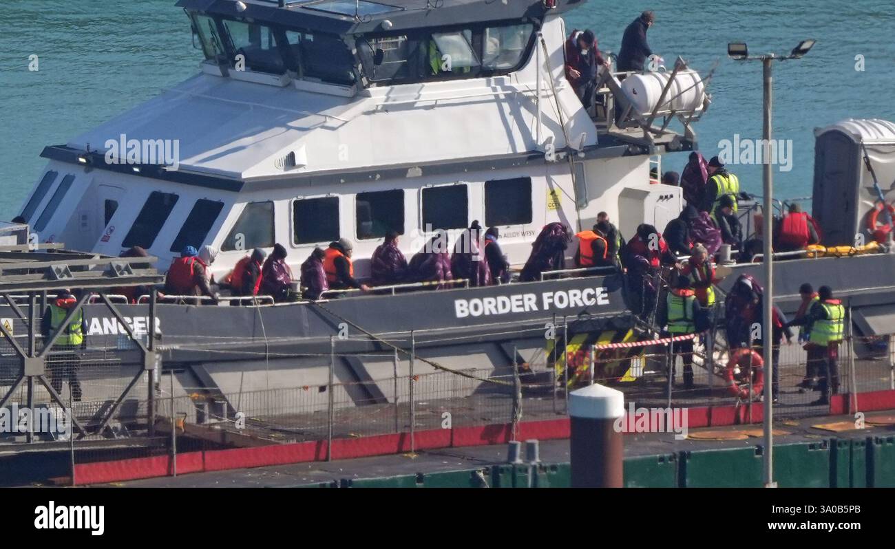 A group of people thought to be migrants are brought in to Dover, Kent ...