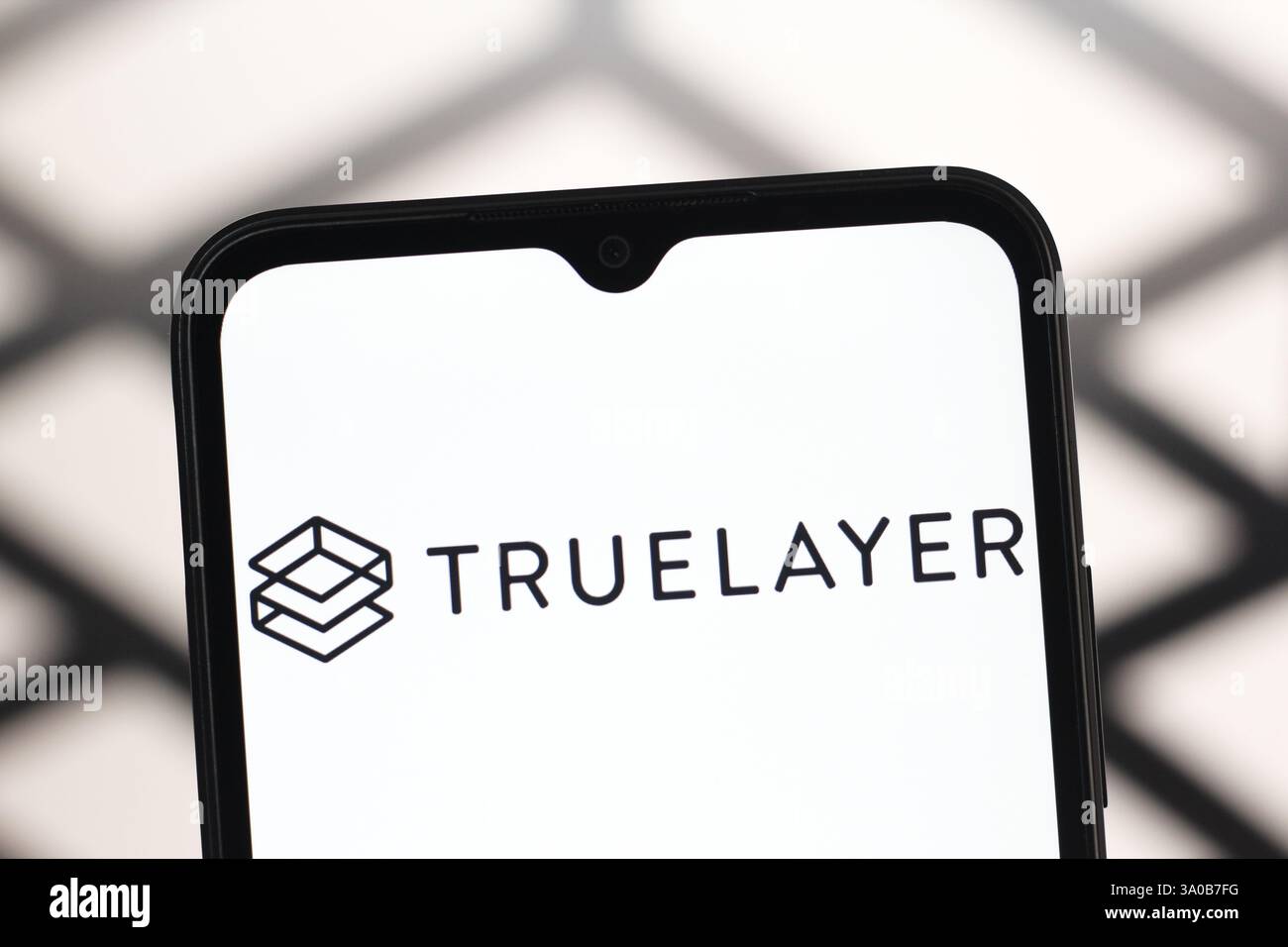 In this photo illustration, the TrueLayer Limited logo is seen displayed on a smartphone screen ...