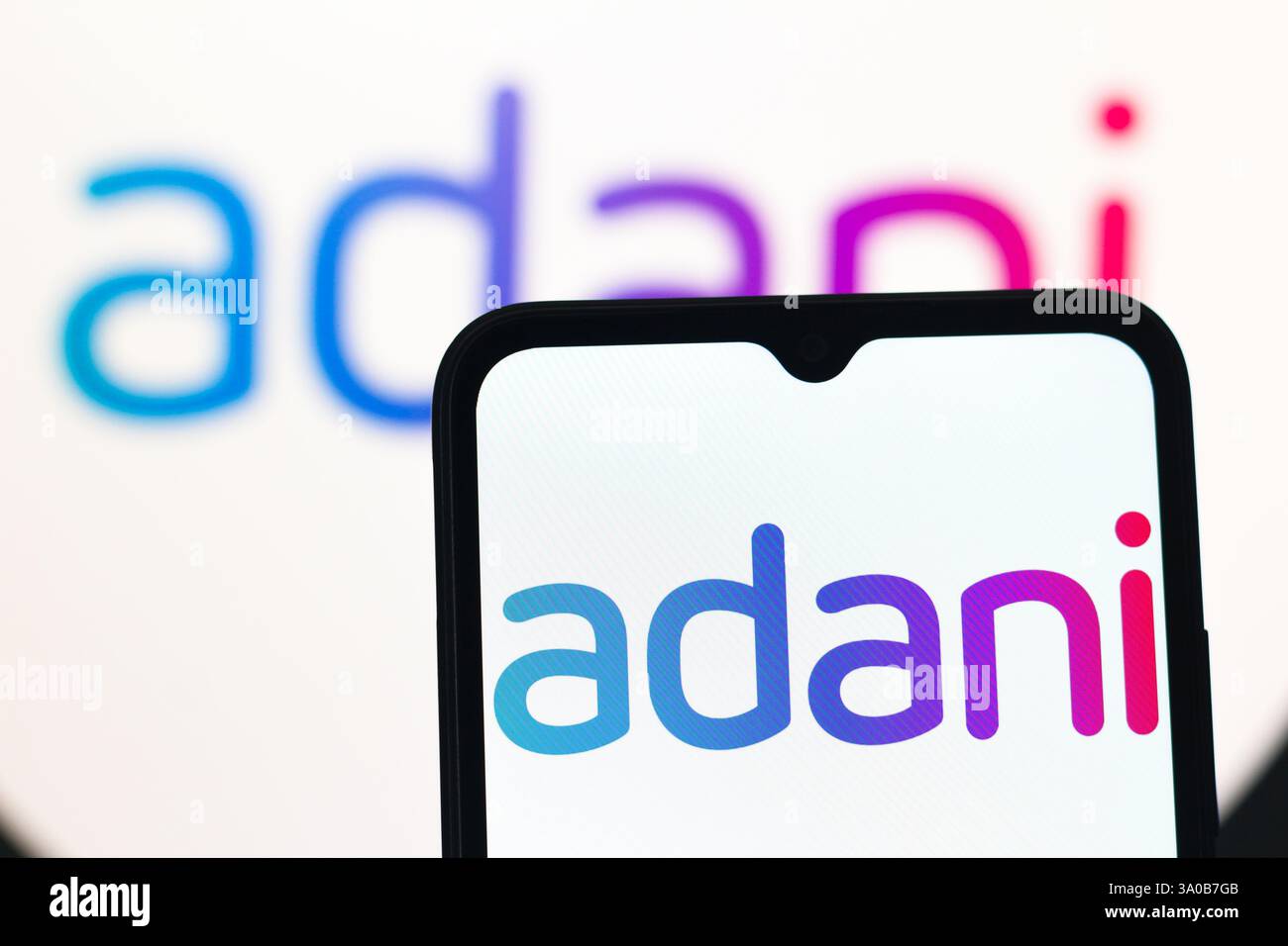 In this photo illustration, the Adani Group logo is seen displayed on a ...