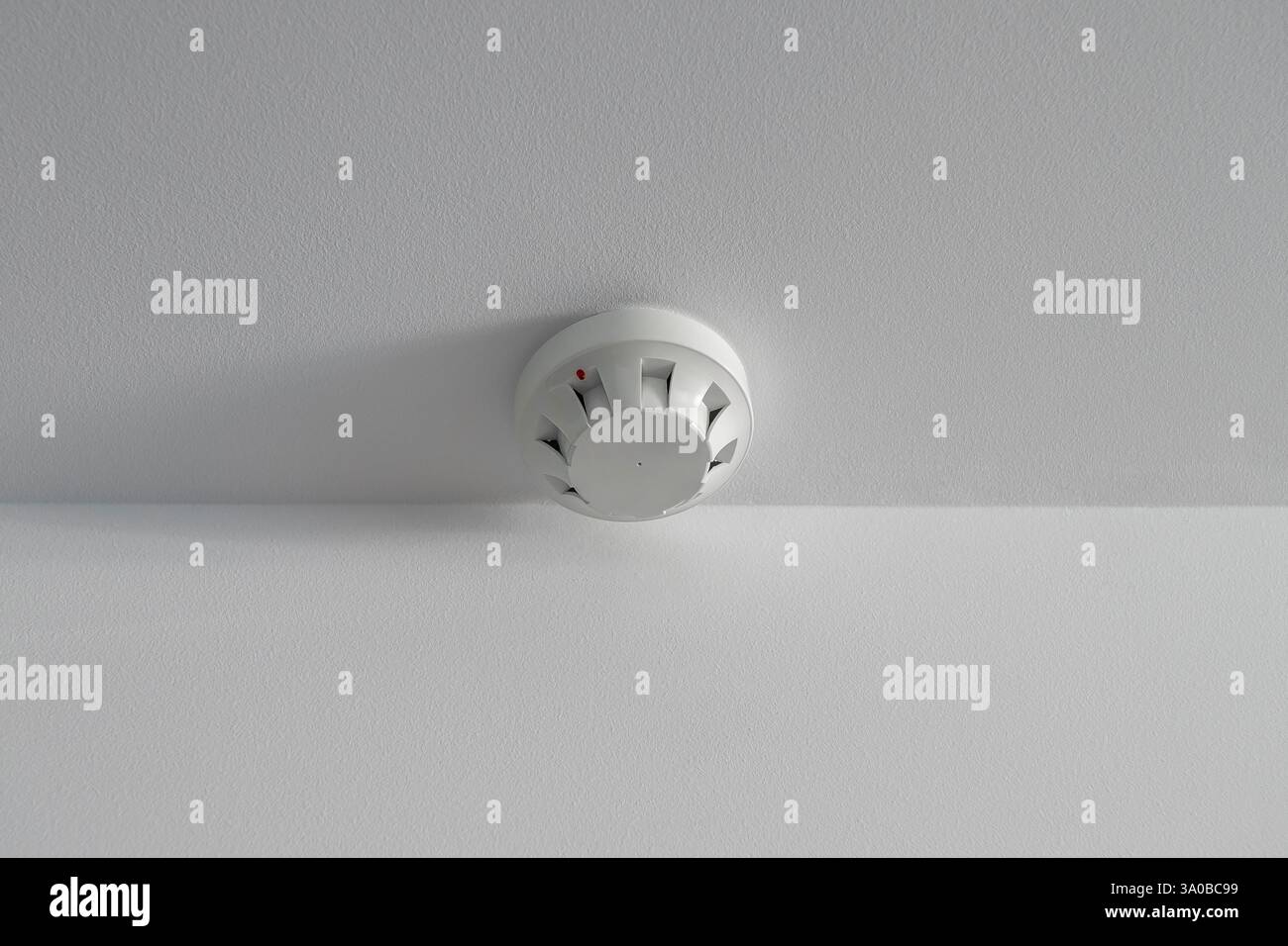 Safety engineering. Fire alarm sensor on white ceiling Stock Photo - Alamy