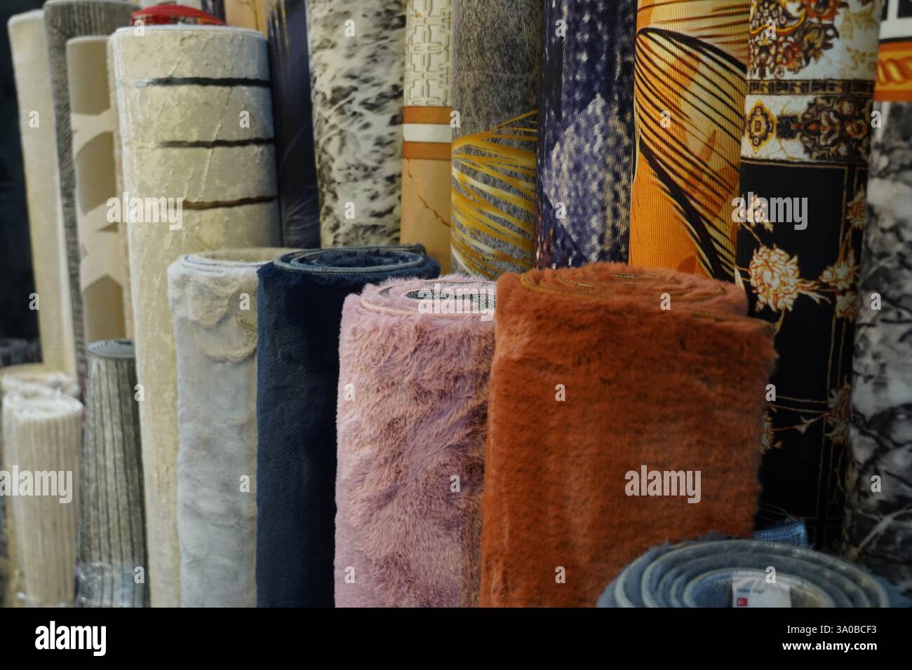 Rolls of carpets and rugs of different textures. Textile fair Stock ...