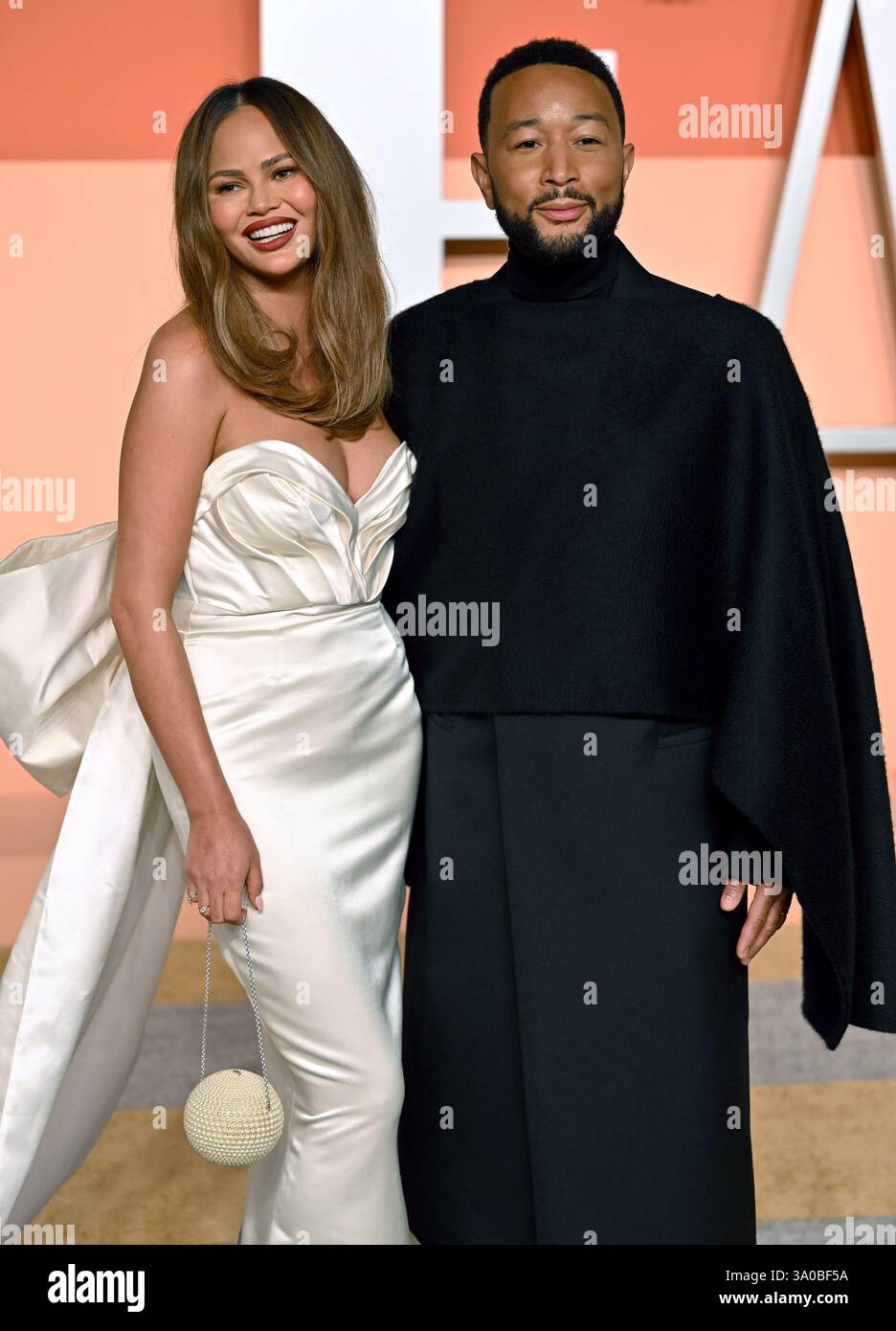 Chrissy Teigen (L) and John Legend arrive for the Vanity Fair Oscar ...