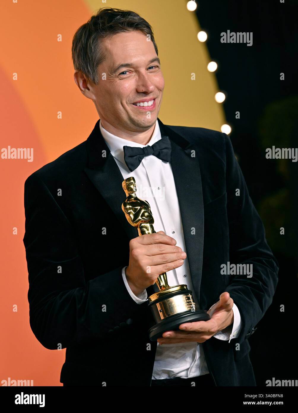 Sean Baker holds his Oscar for Best Director as he arrives for the Vanity Fair Oscar Party at ...