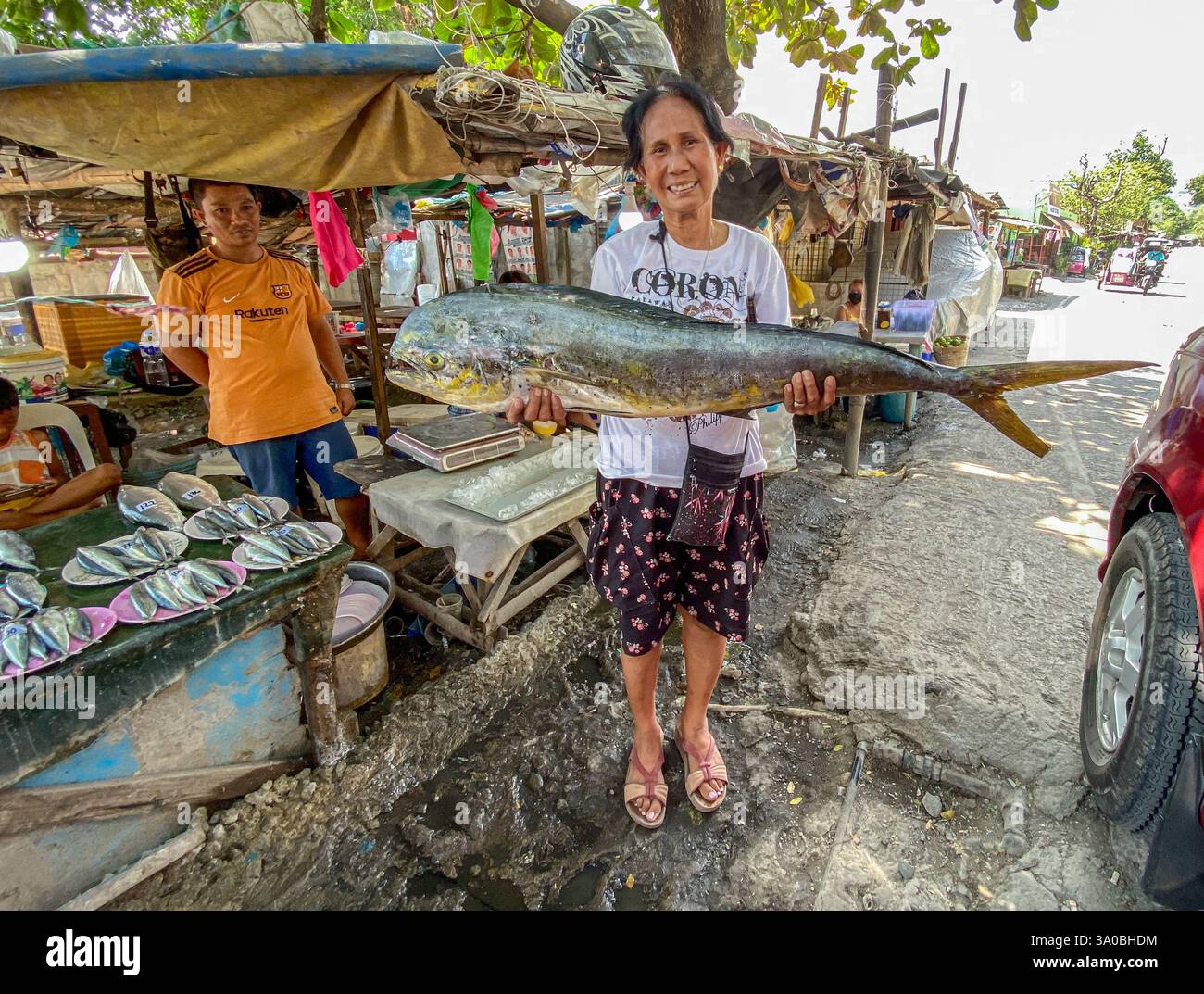Mariveles Bay, Philippines. March 03,2025.An elderly Filipina buying a ...
