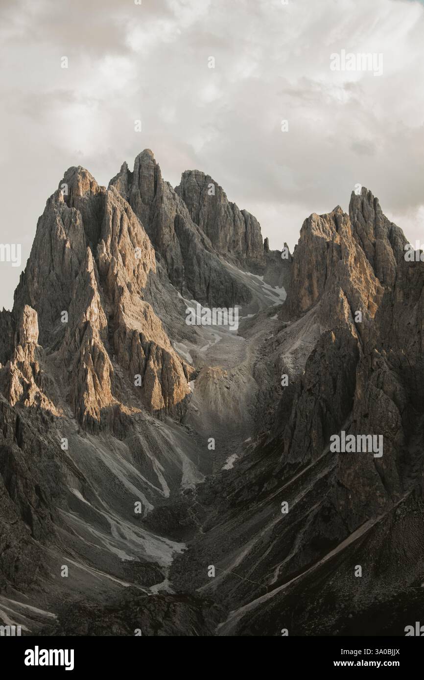 Rugged mountain ranges showcase their dramatic peaks, bathed in soft ...