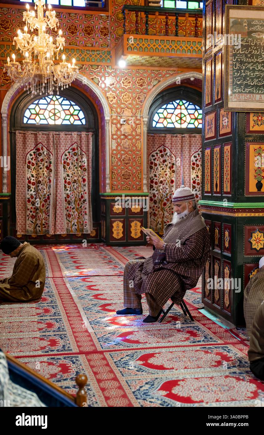 A Kashmiri Muslim man recites from the Islamic book Quran inside a ...
