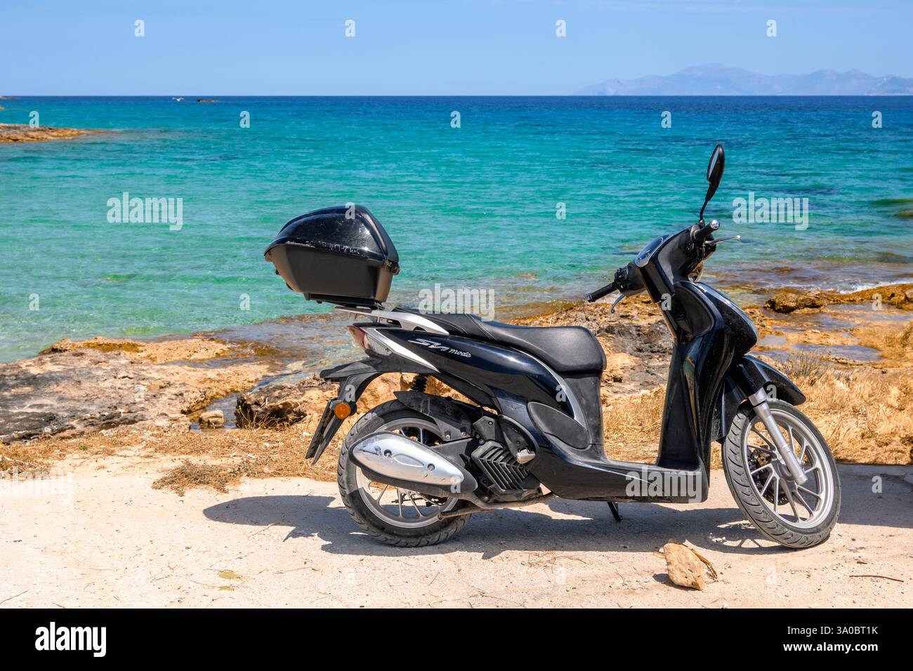 Ano Koufonisi, Greece - May 15, 2024: A scooter parked on the shores of ...