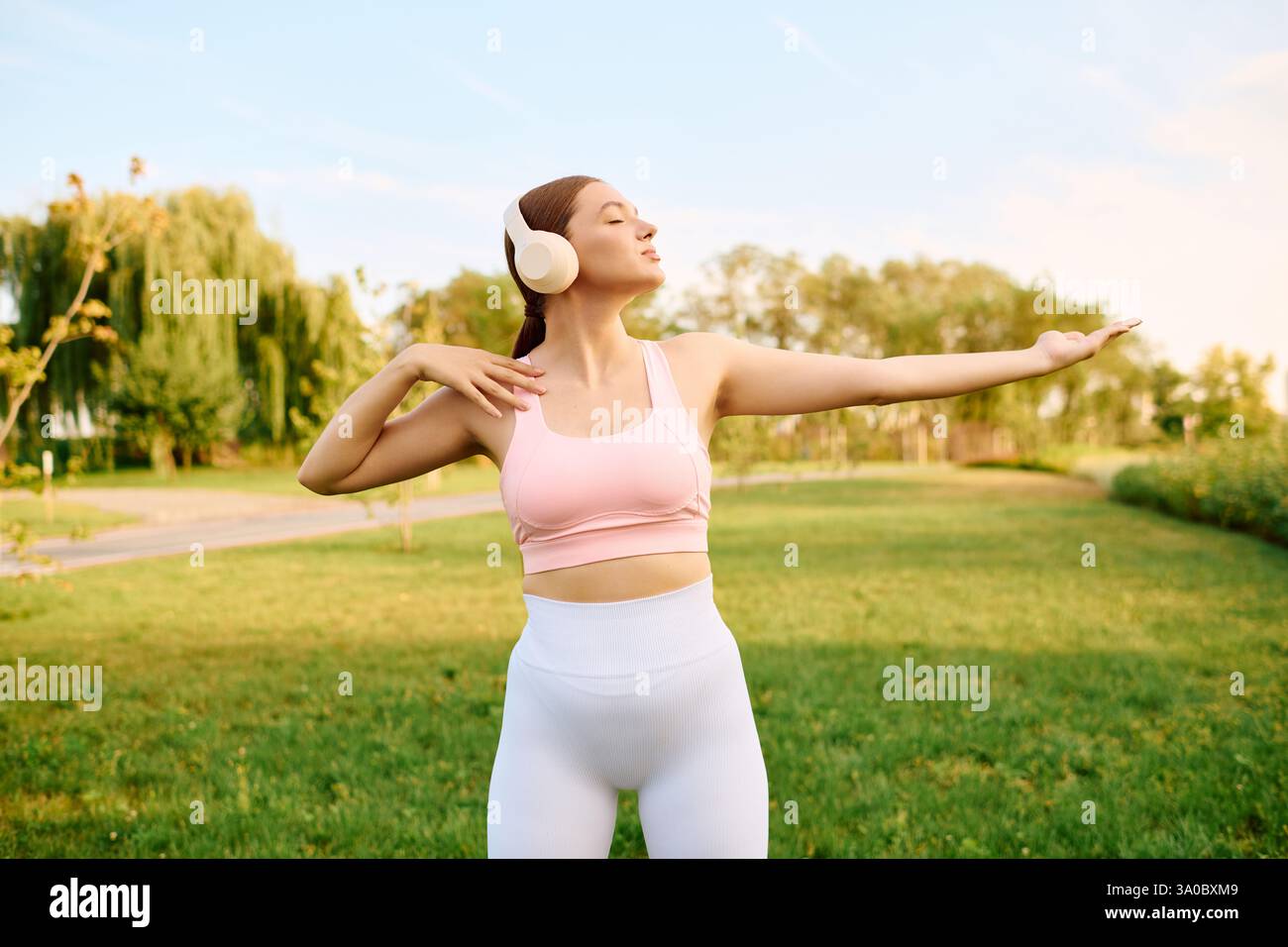 A young athlete embraces the joy of exercise while wearing headphones ...