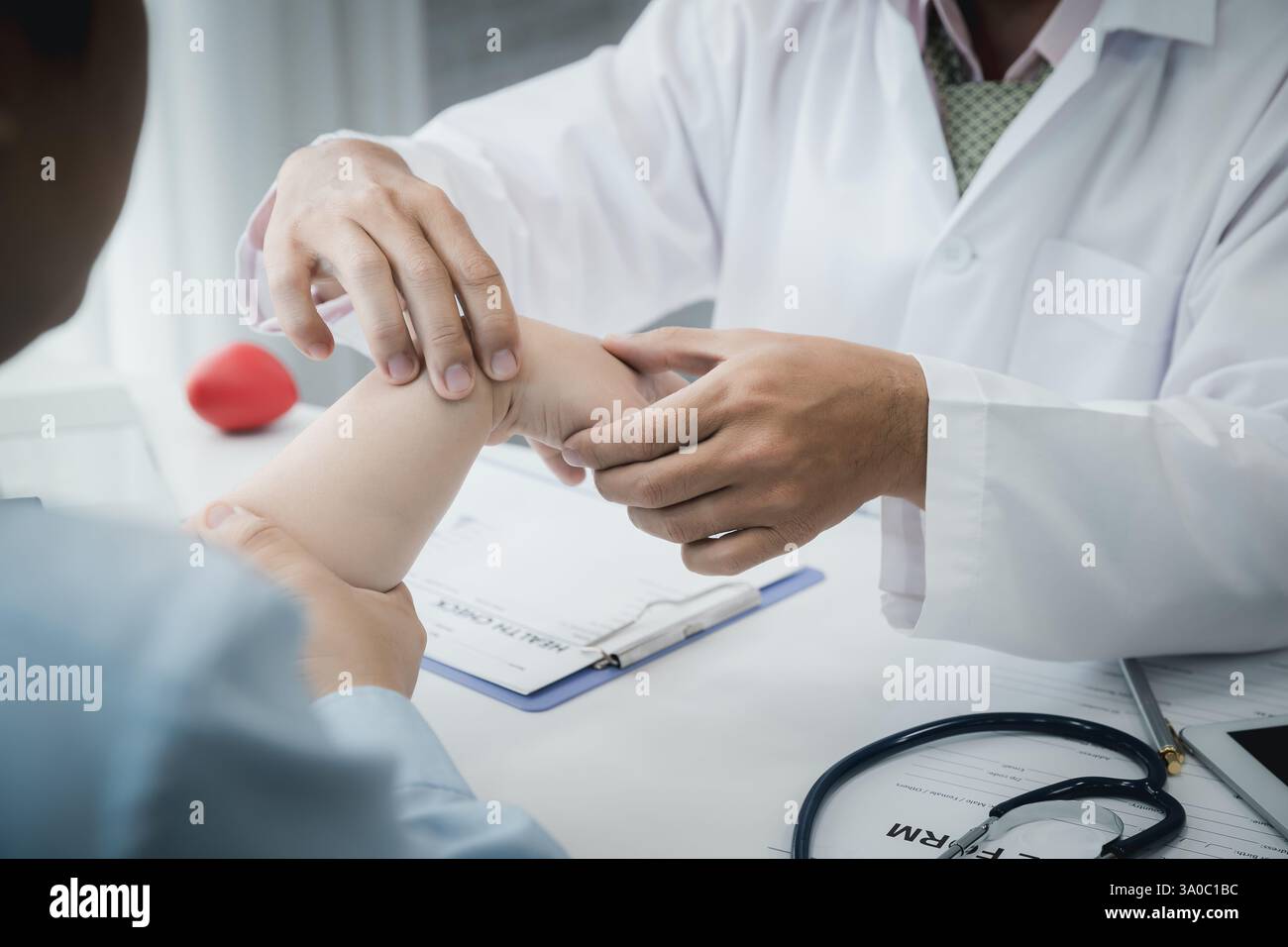Orthopaedic doctor doing physical examination patient with wrist pain ...