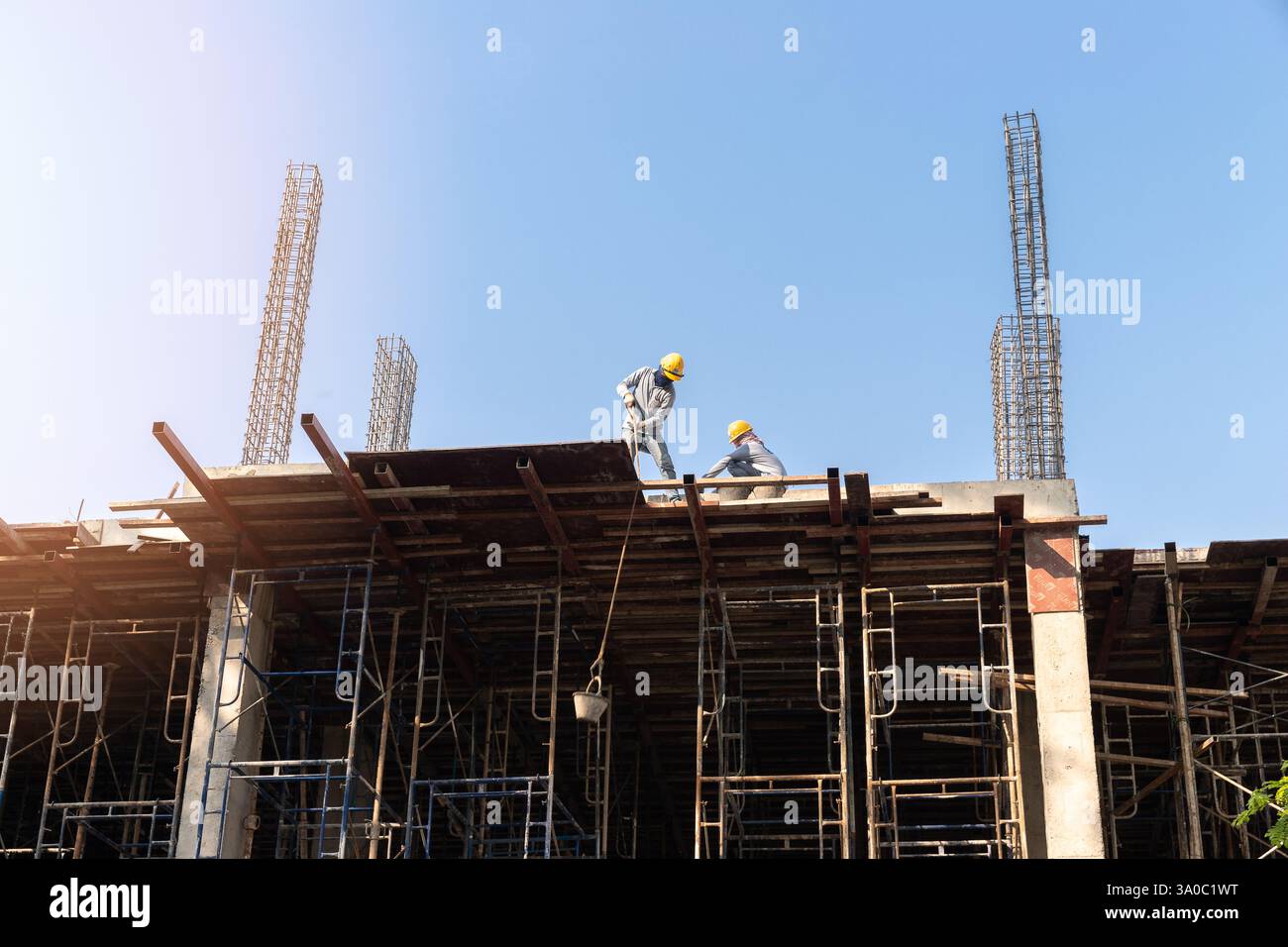 Construction workers or builder workers working on contruction site ...