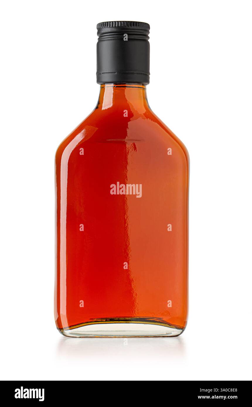 Glass whiskey bottle full of amber liquid with black cap, isolated on ...