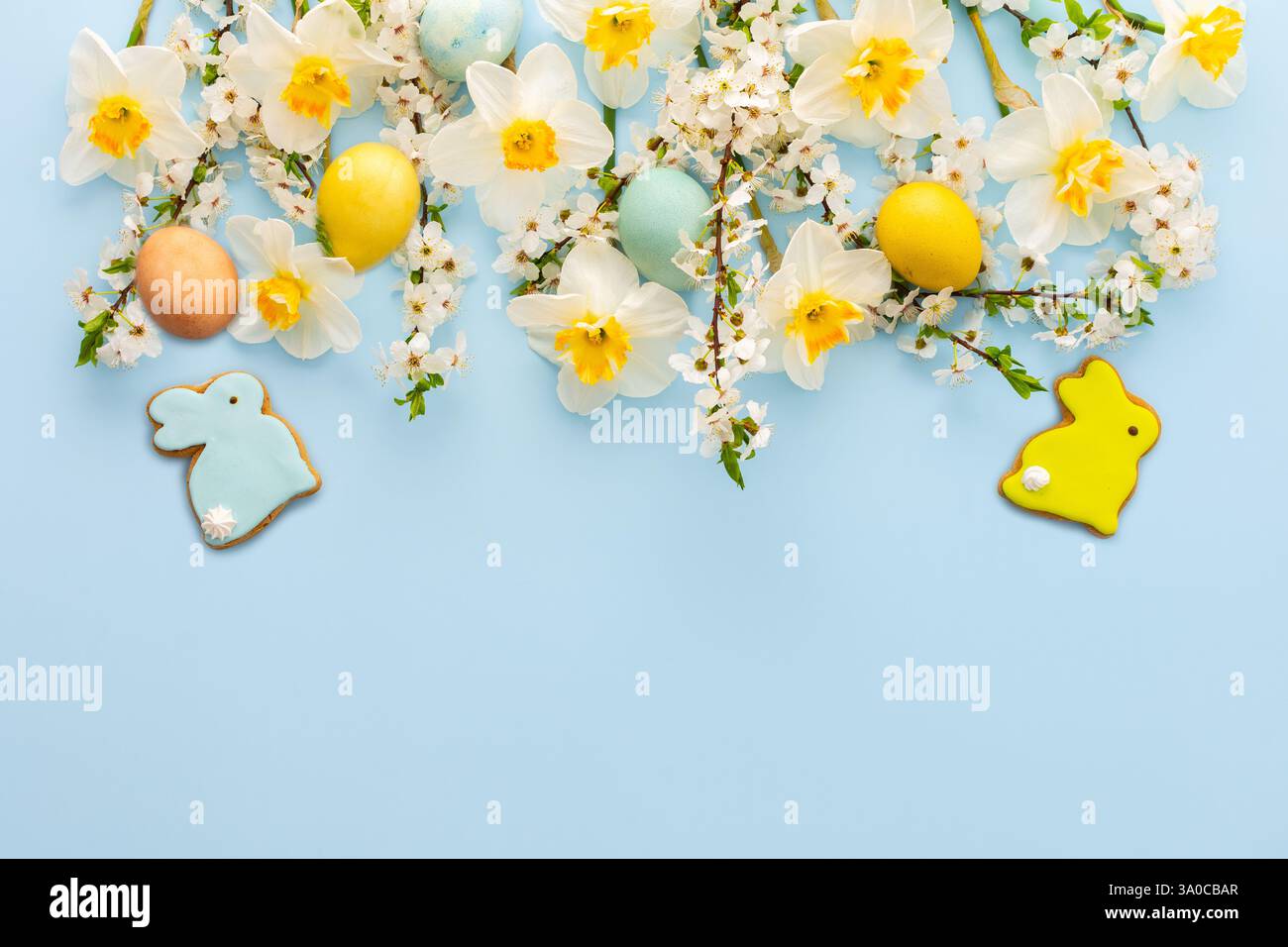 Festive background with spring flowers and naturally colored eggs and ...