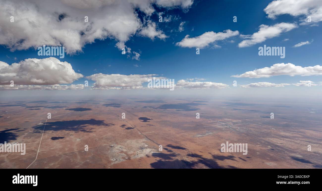 aerial landscape with bright clouds casting shadows over sparse farms ...