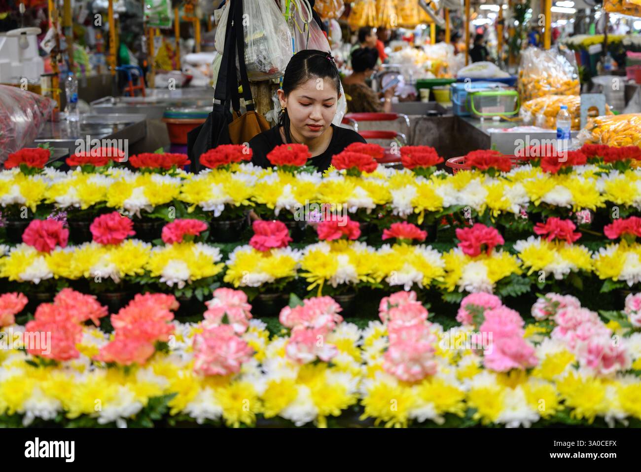 Bangkok, Thailand. March 2rd 2025. A Thai woman at a stall selling ...