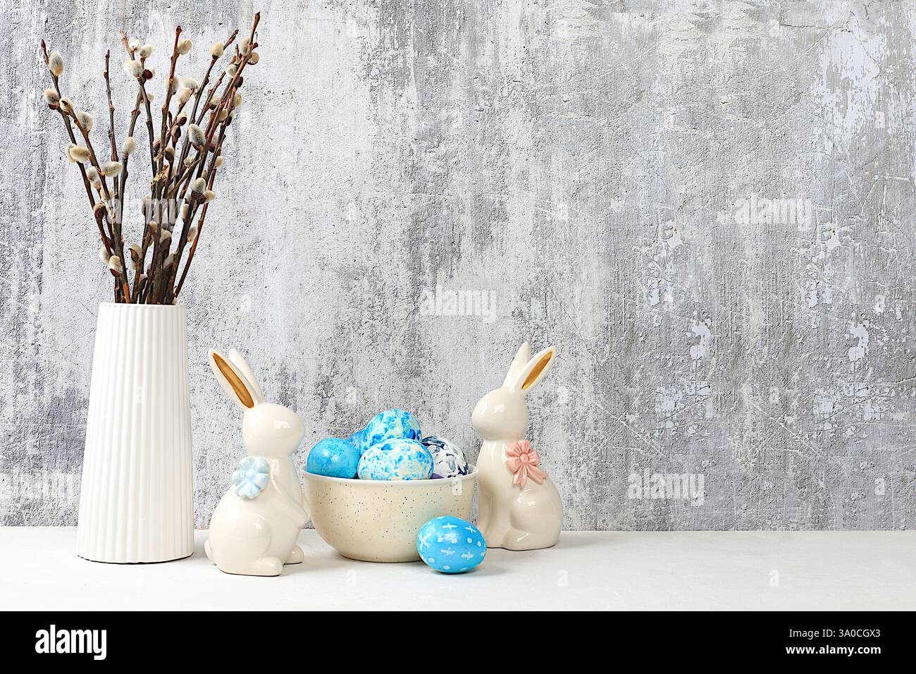 Composition with decorated Easter eggs, a rabbit and willow branches in ...