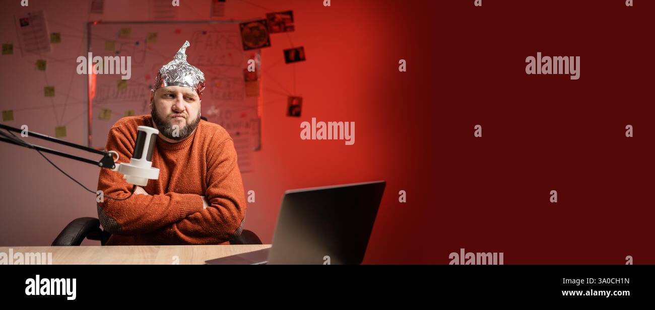 Bearded frowning sad man in aluminum foil hat hold hands crossed folded ...