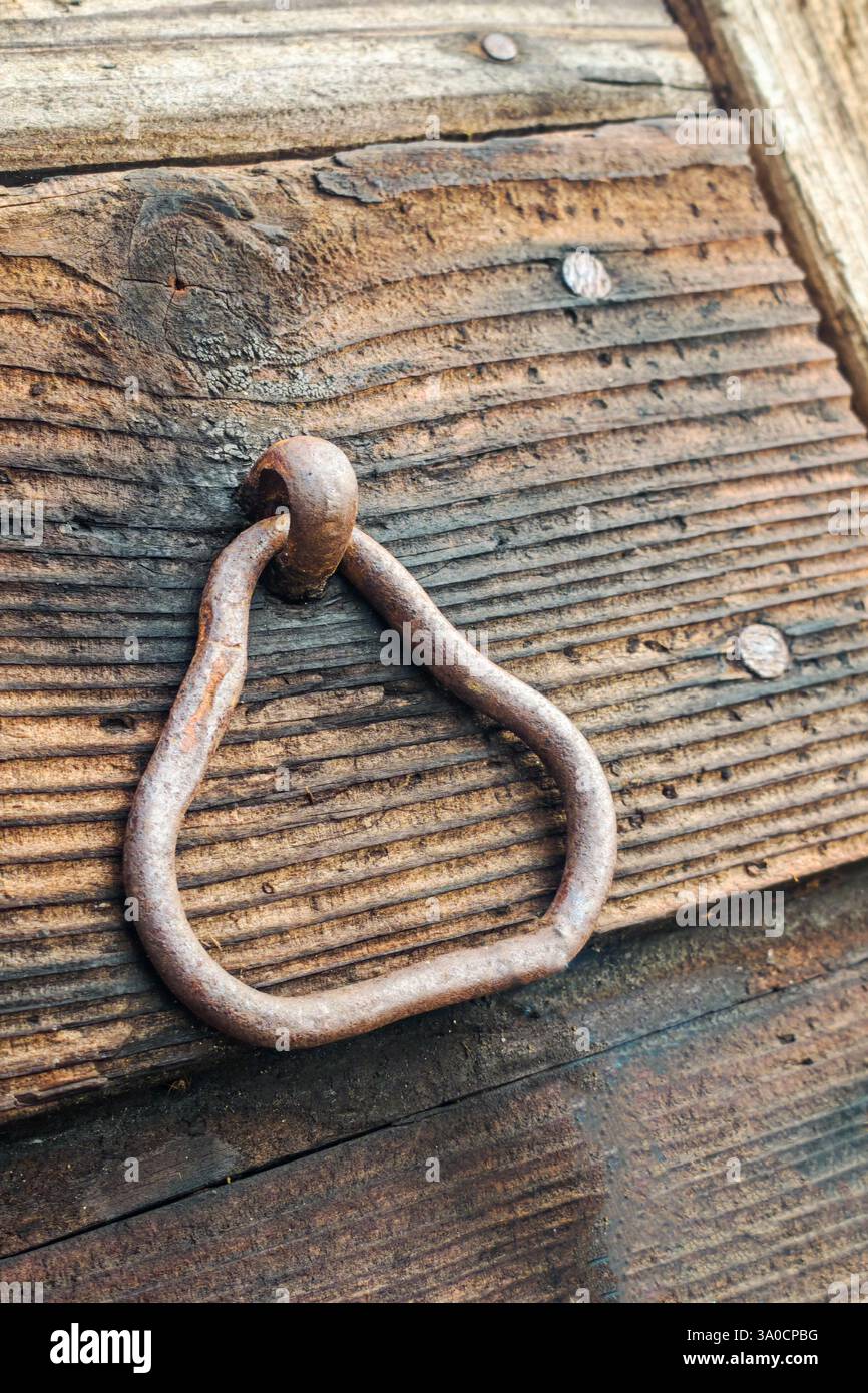 Rusty metal handle on weathered wooden door Stock Photo - Alamy