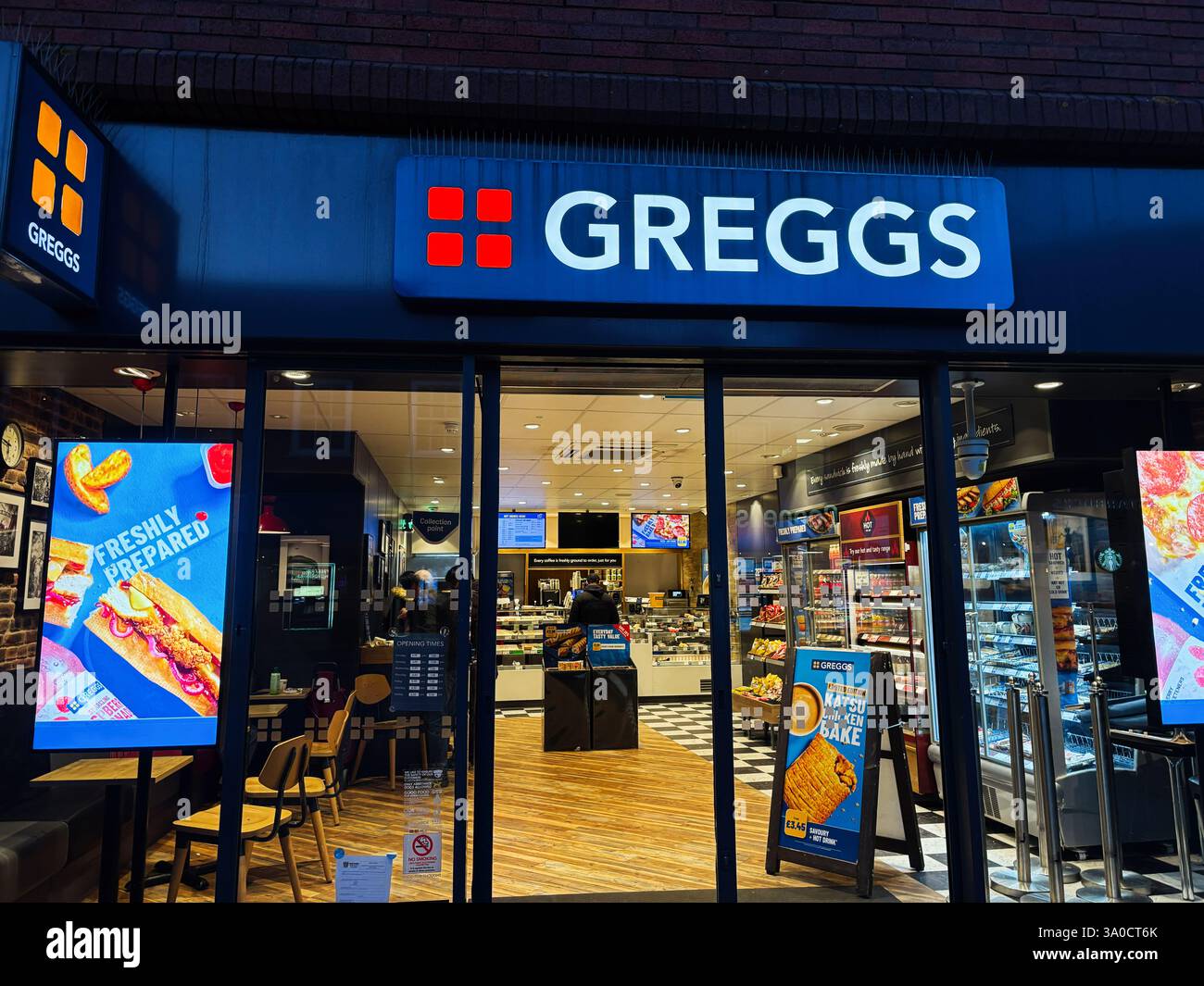 London, UK - March 02, 2025: View of a Greggs plc bakery illuminated ...