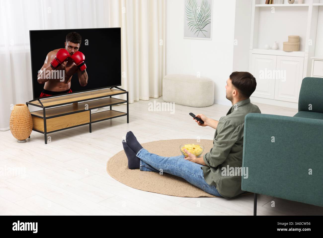 Man watching boxing fight on TV set at home Stock Photo - Alamy