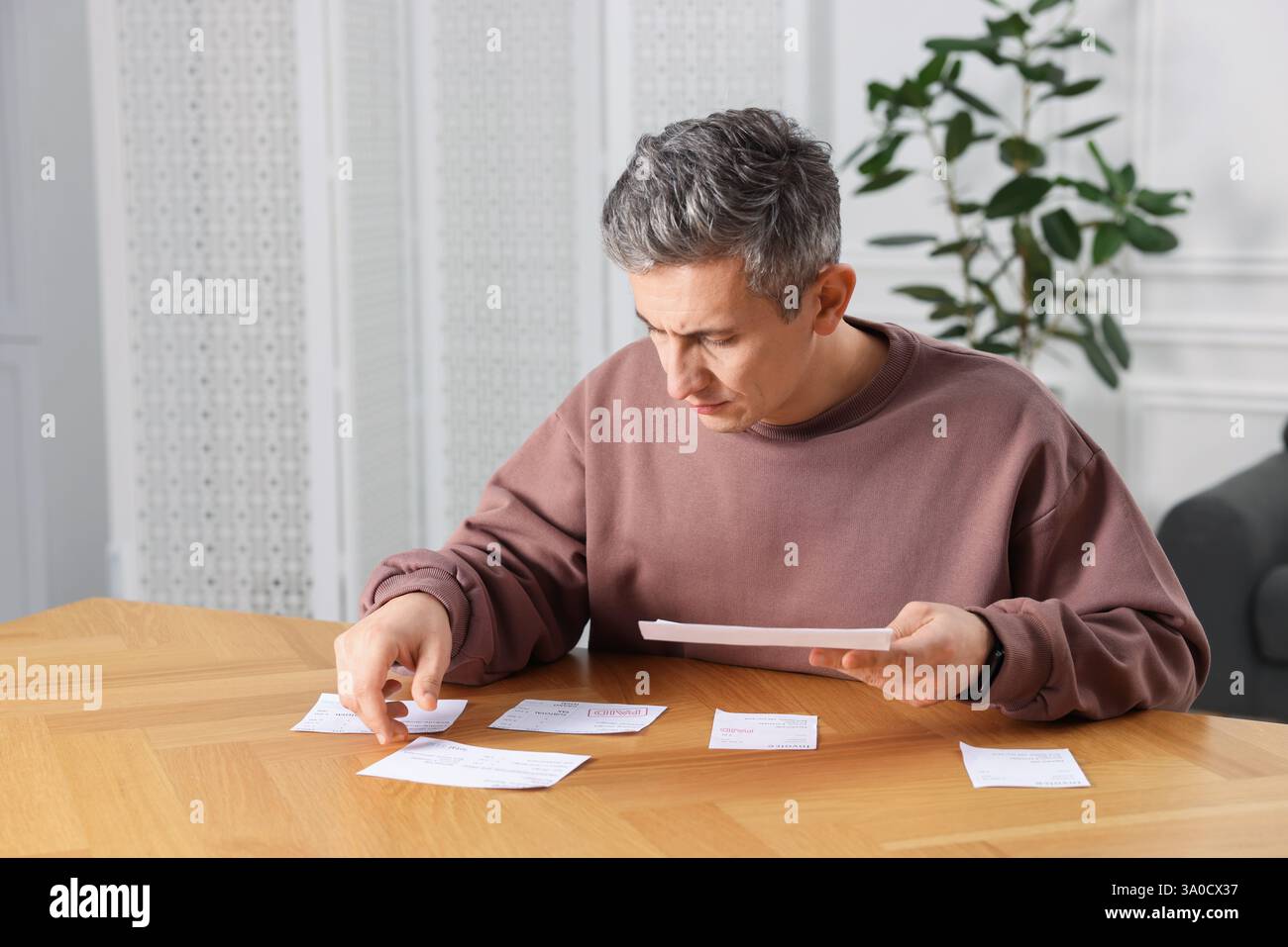 Man checking bills taxes home hi-res stock photography and images - Alamy