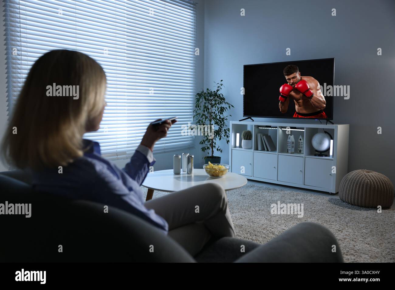 Woman watching boxing fight on TV set at home Stock Photo - Alamy