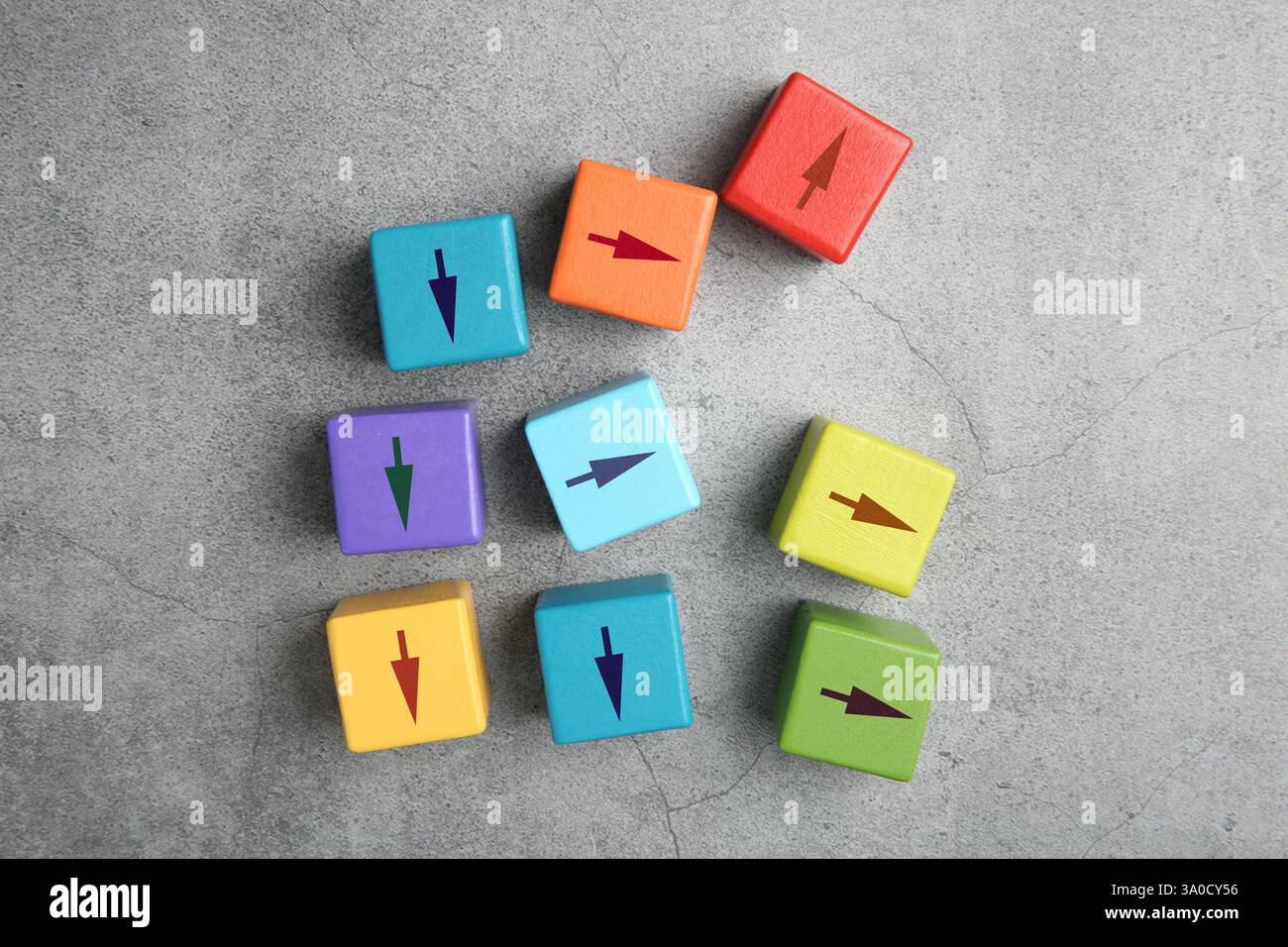 Colorful cubes with arrows pointing in different directions on grey ...