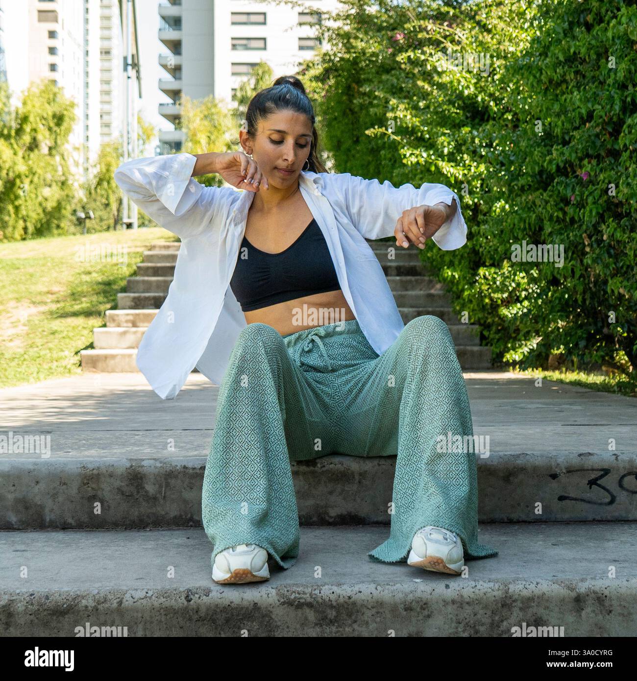 Expressive dancer creating art with movement while seated in nature ...