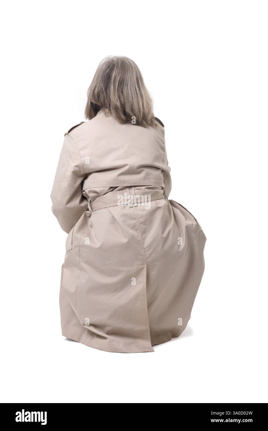 back view of a woman squatting and looking up on white background Stock ...