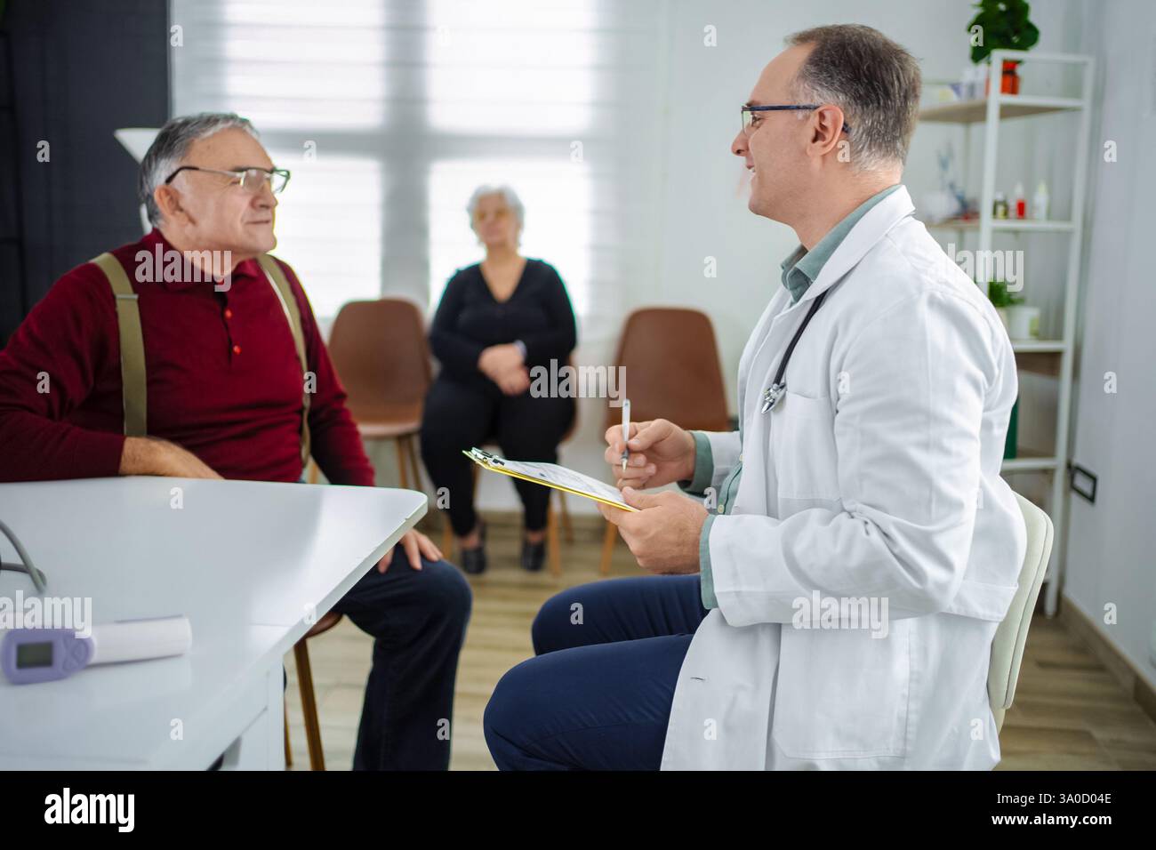 Elderly man's health check in a modern medical office setting Stock ...