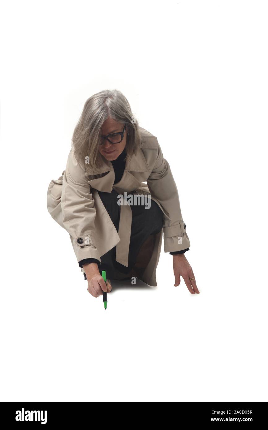 front view of a woman squatting who is drawing with a marker on the ...