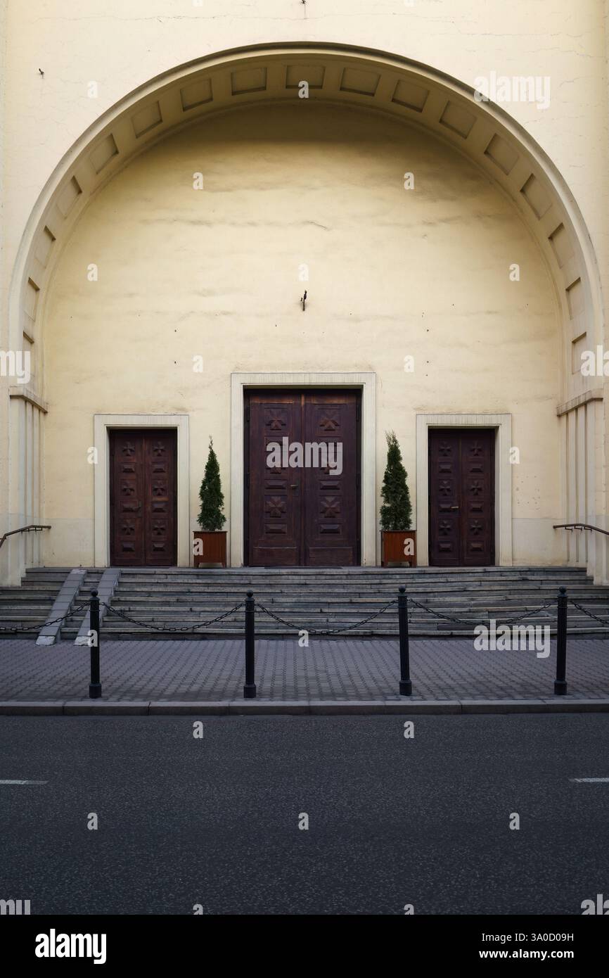 Large archway with three wooden doors facing the street Stock Photo - Alamy