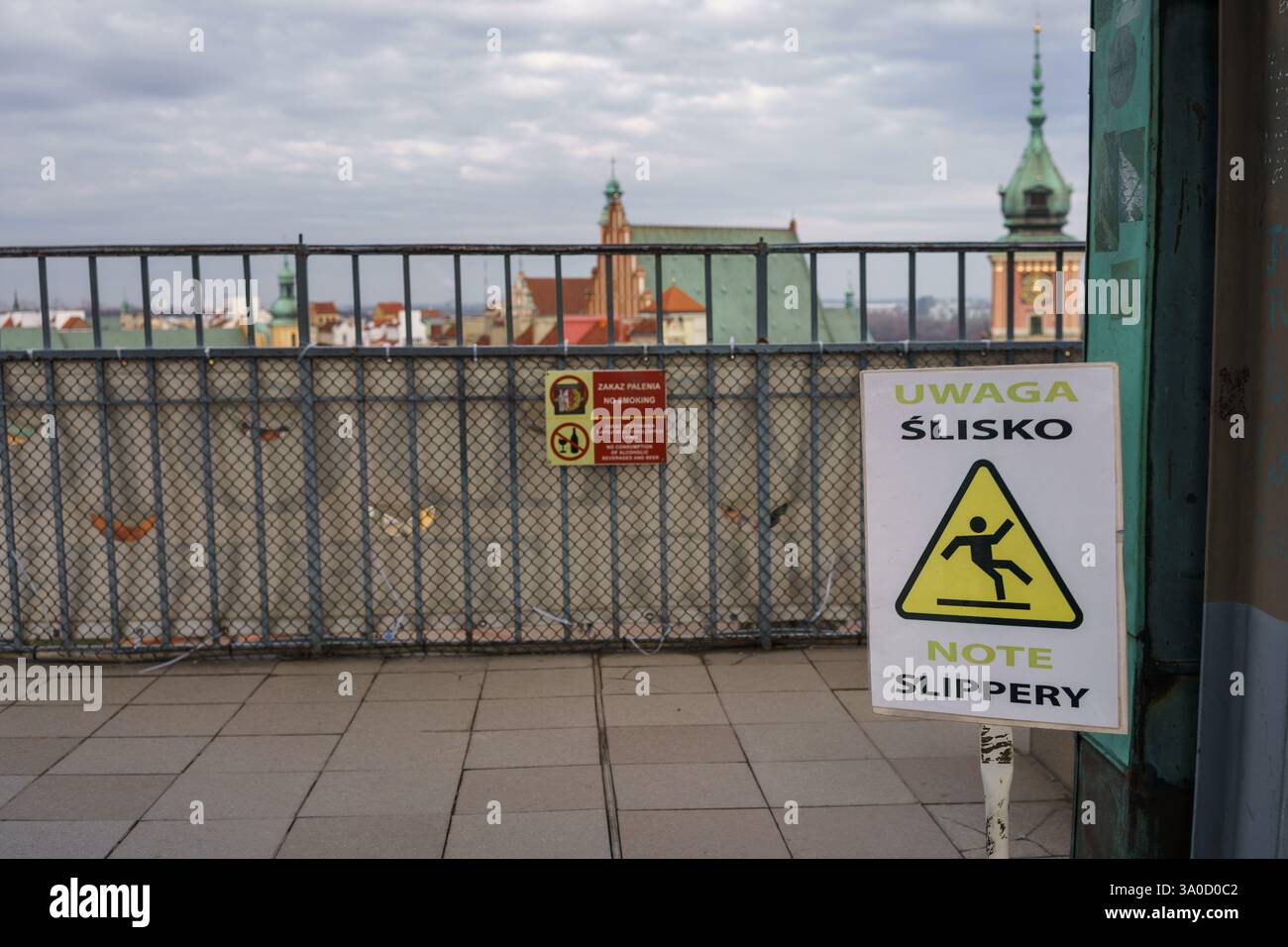 Caution sign on a viewing platform with the words "Note Slippery" in ...