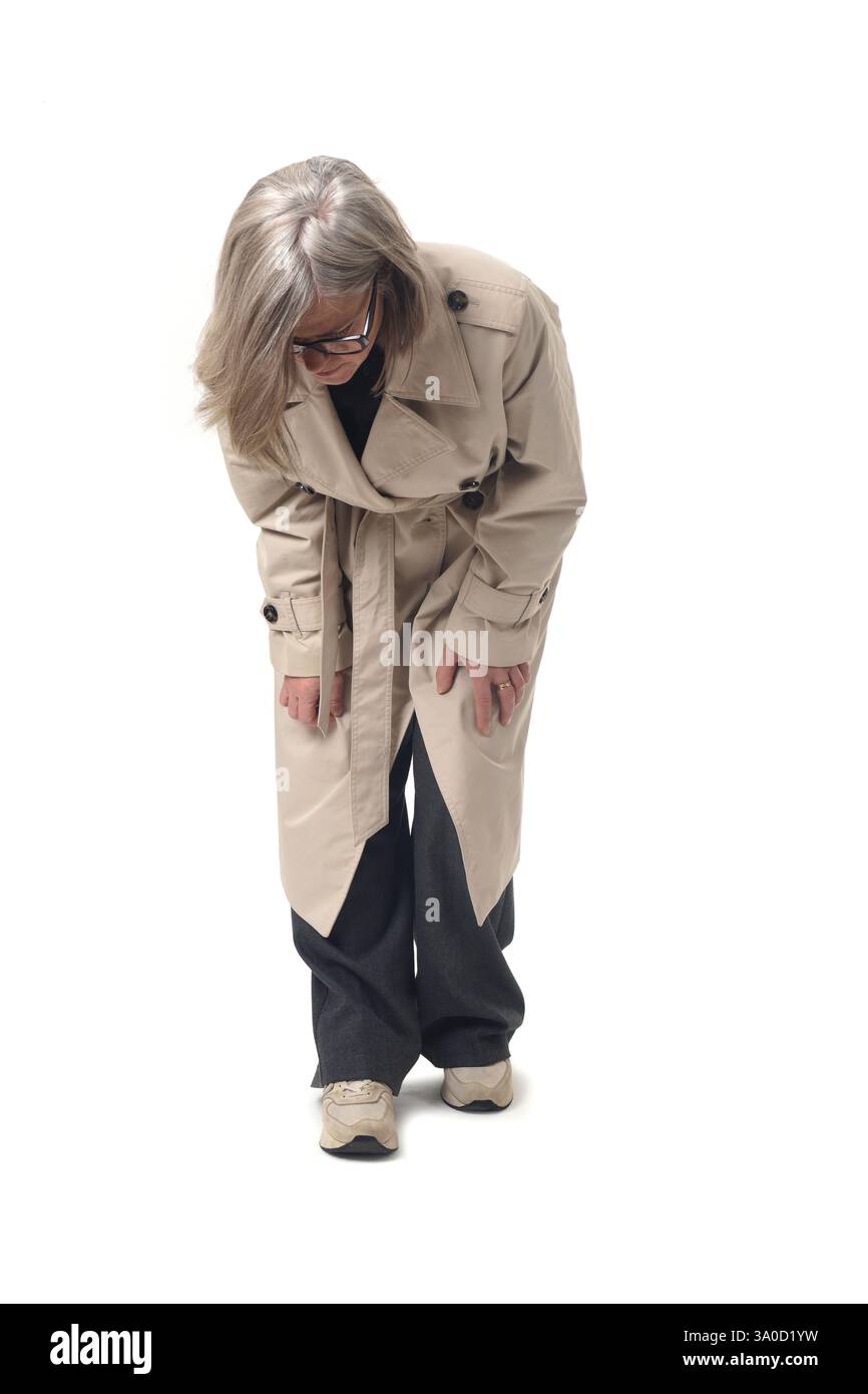 front view of a woman crouching looking for something on the ground on ...