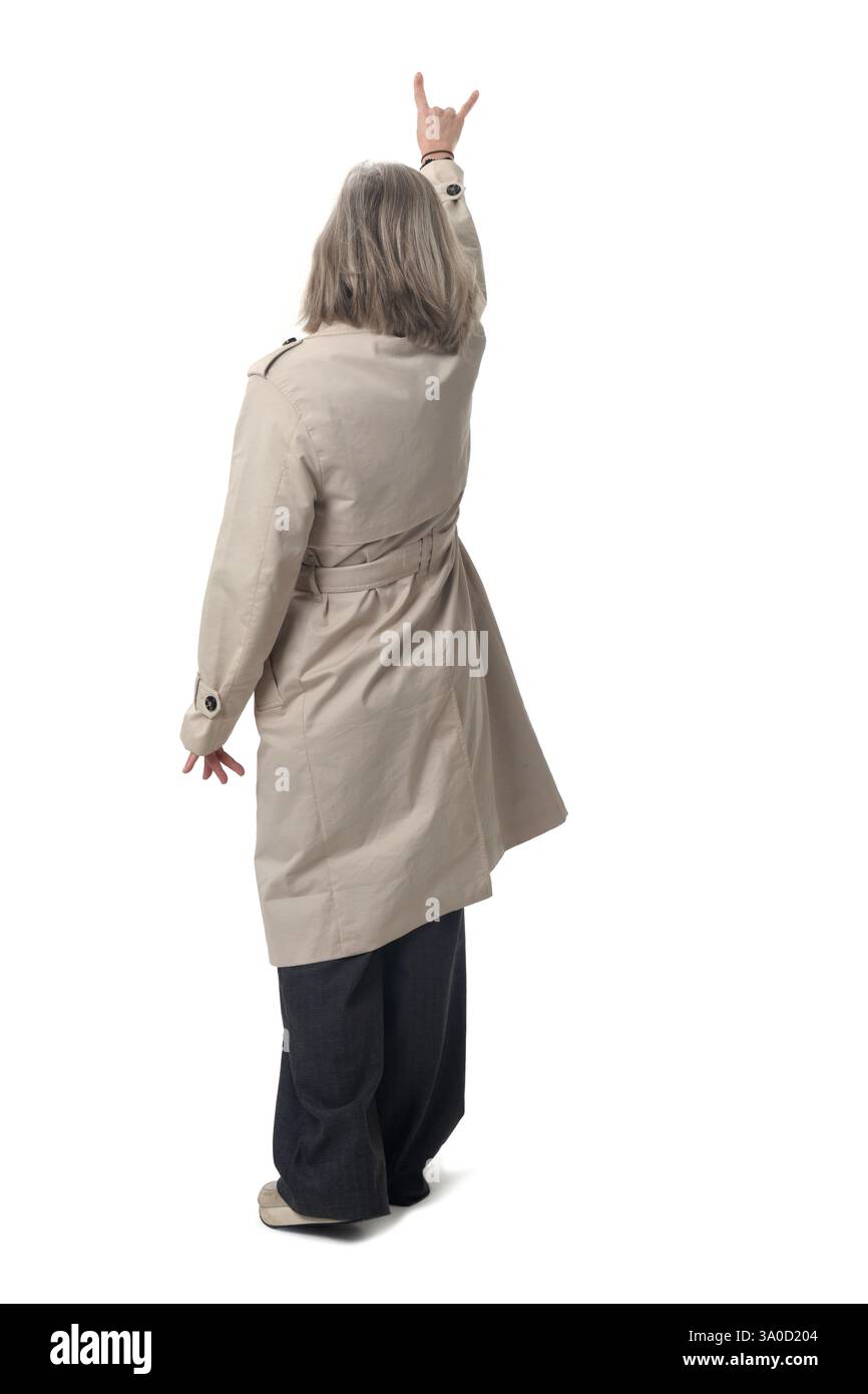 back view of a woman showing the horns sign with fingers on white ...