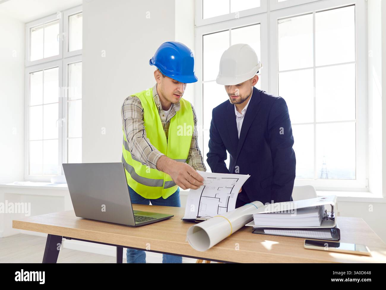 Engineer discussing with foreman design project for housing working on ...