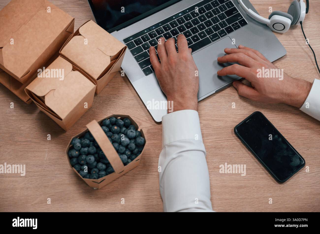 Typing on keybord. Top view of hands of the man that is working by ...